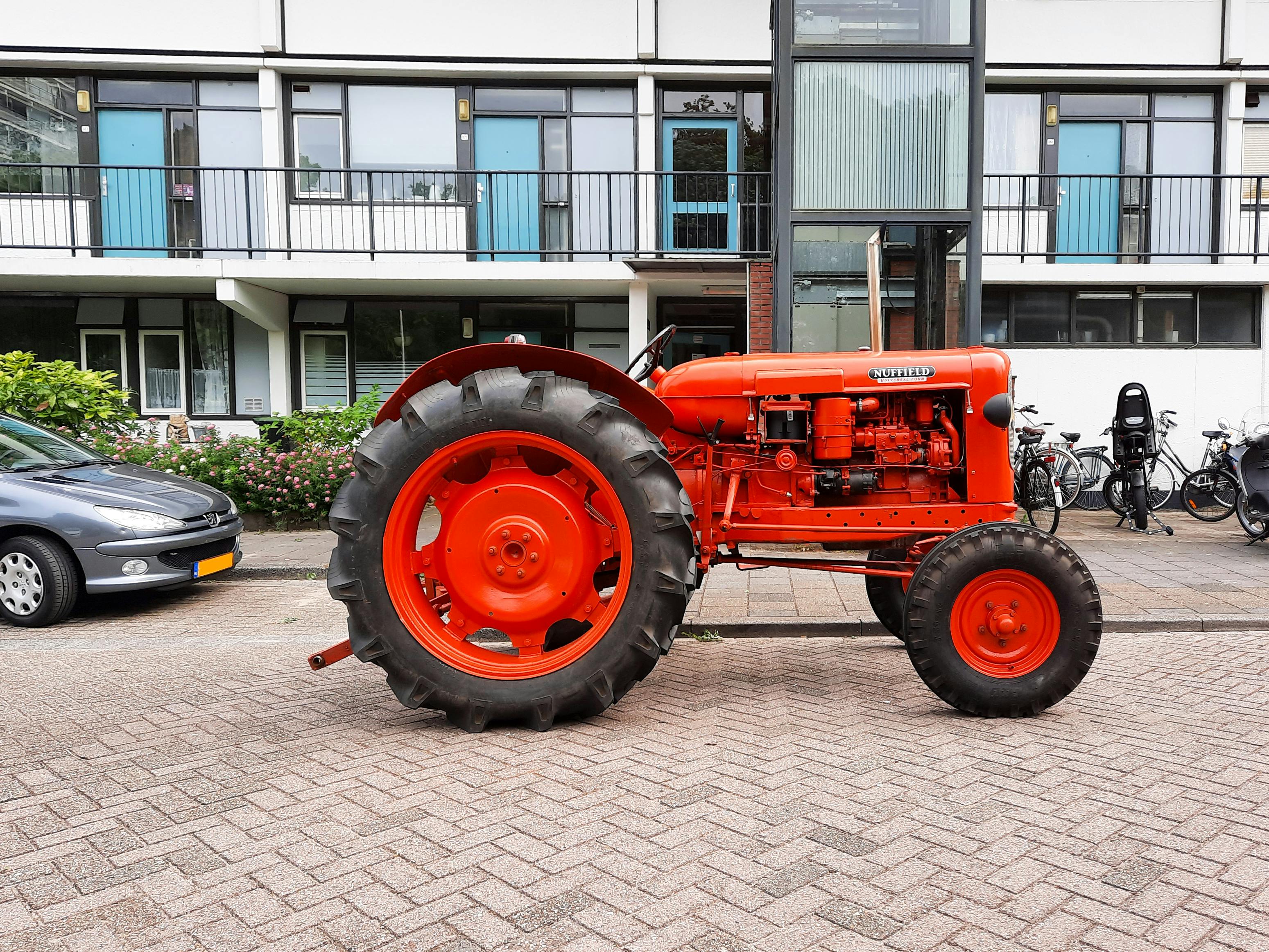 Vintage Nuffield Tractor in Urban Setting · Free Stock Photo