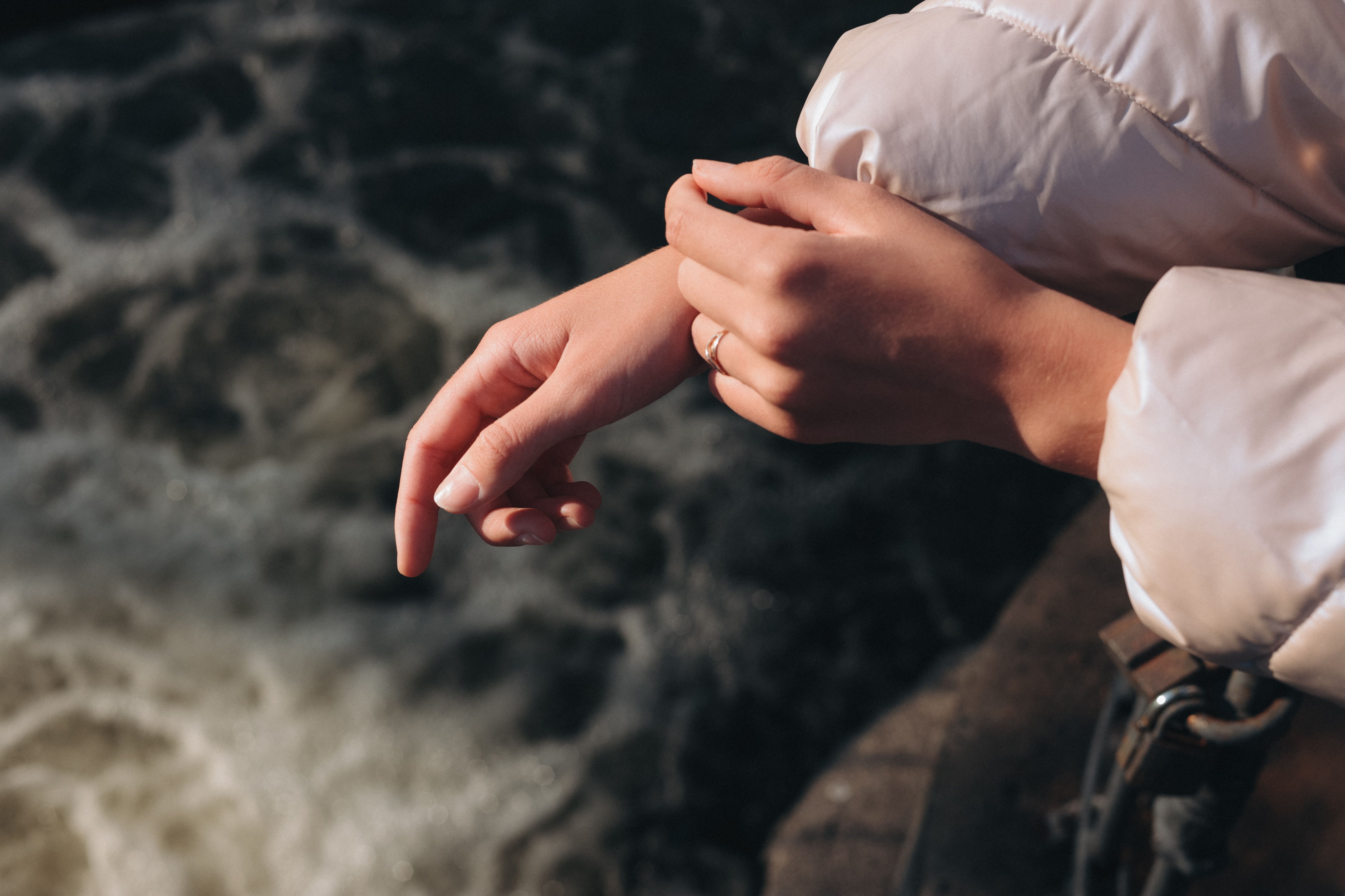 Close-up of Hands by Railing Over Water · Free Stock Photo