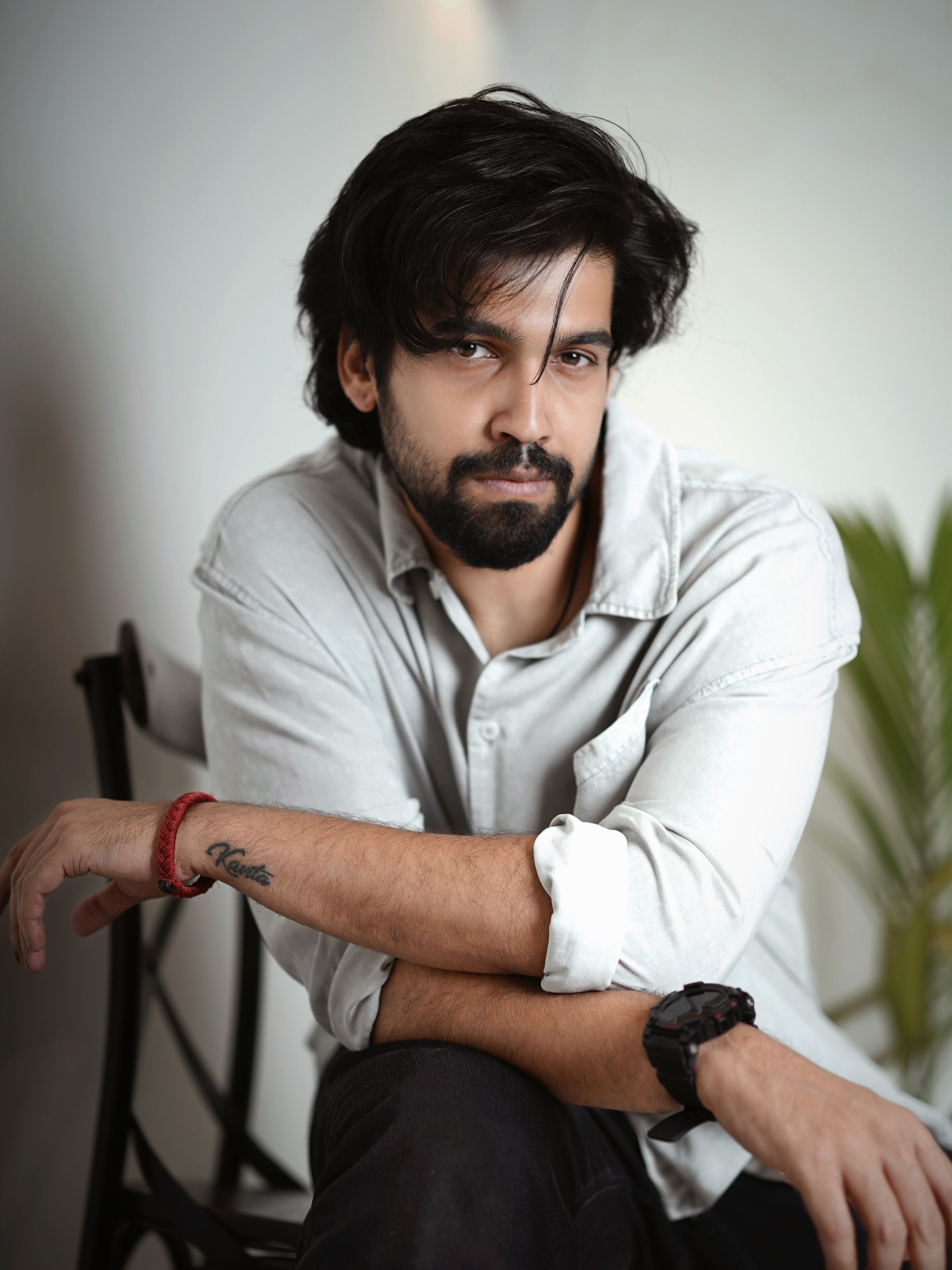 Portrait of a Man Seated Calmly Indoors · Free Stock Photo
