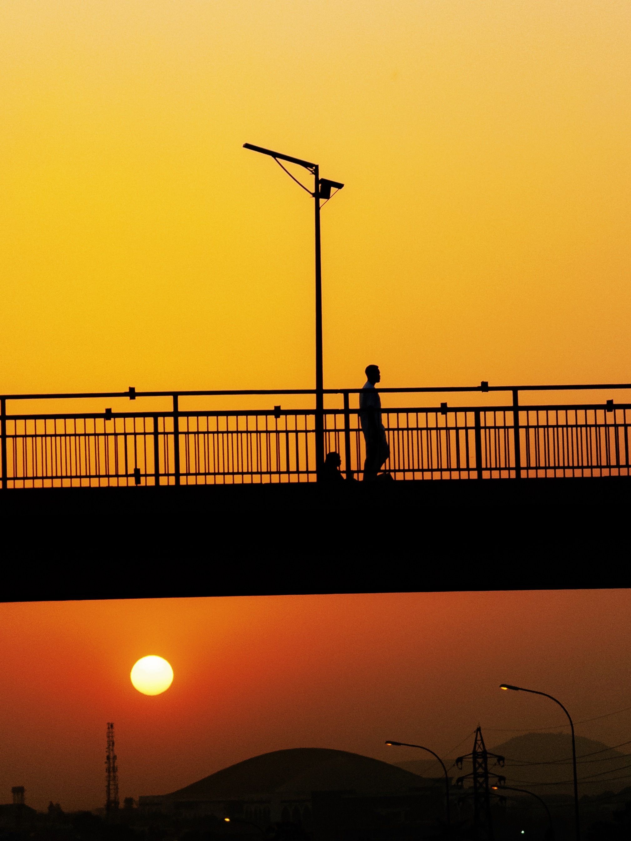 Silhouette on a Bridge at Abuja Sunset · Free Stock Photo