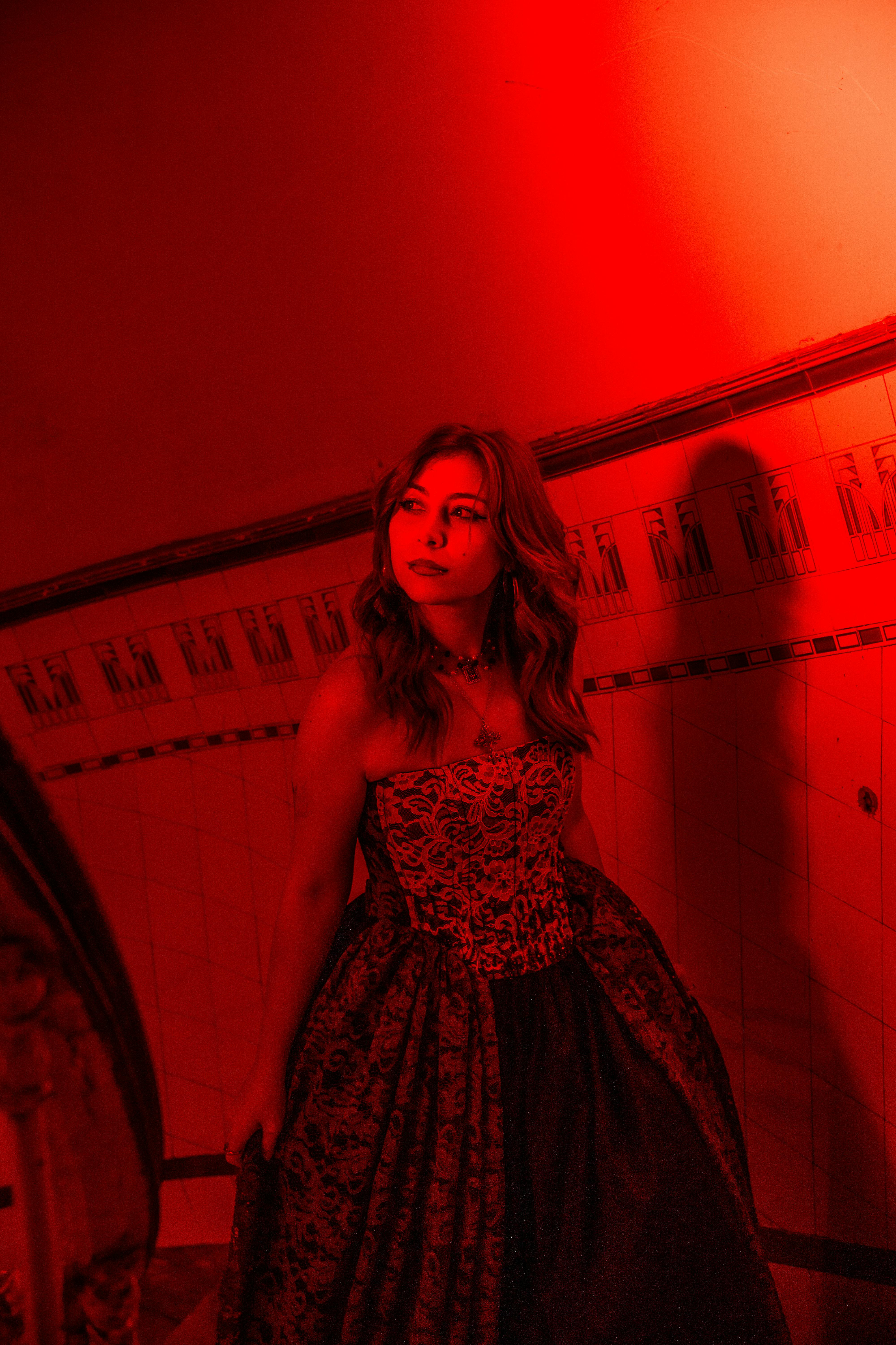 Woman in Elegant Gown in Dramatic Red Lighting · Free Stock Photo
