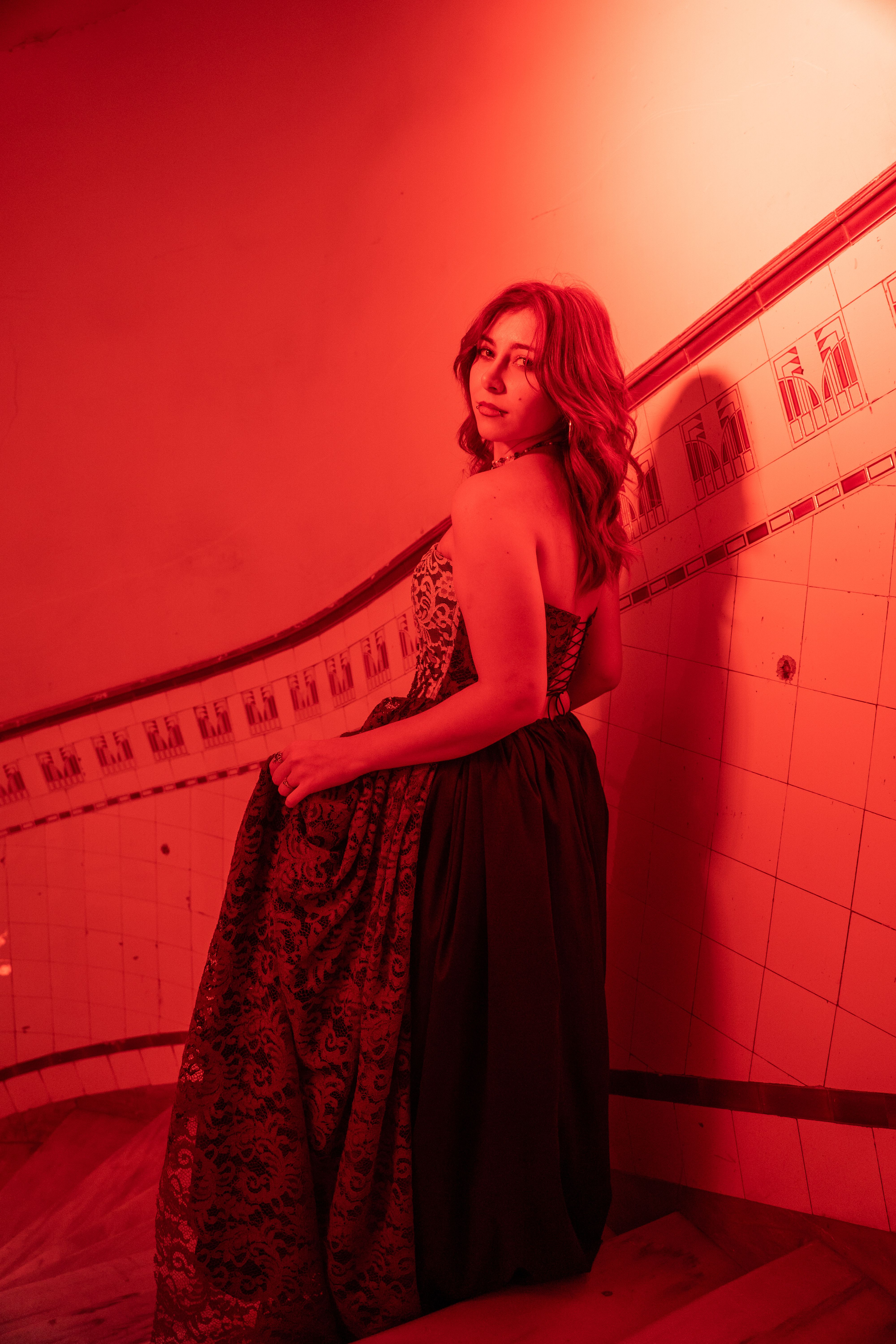 Elegant Woman in Dramatic Red Lighting Indoors · Free Stock Photo
