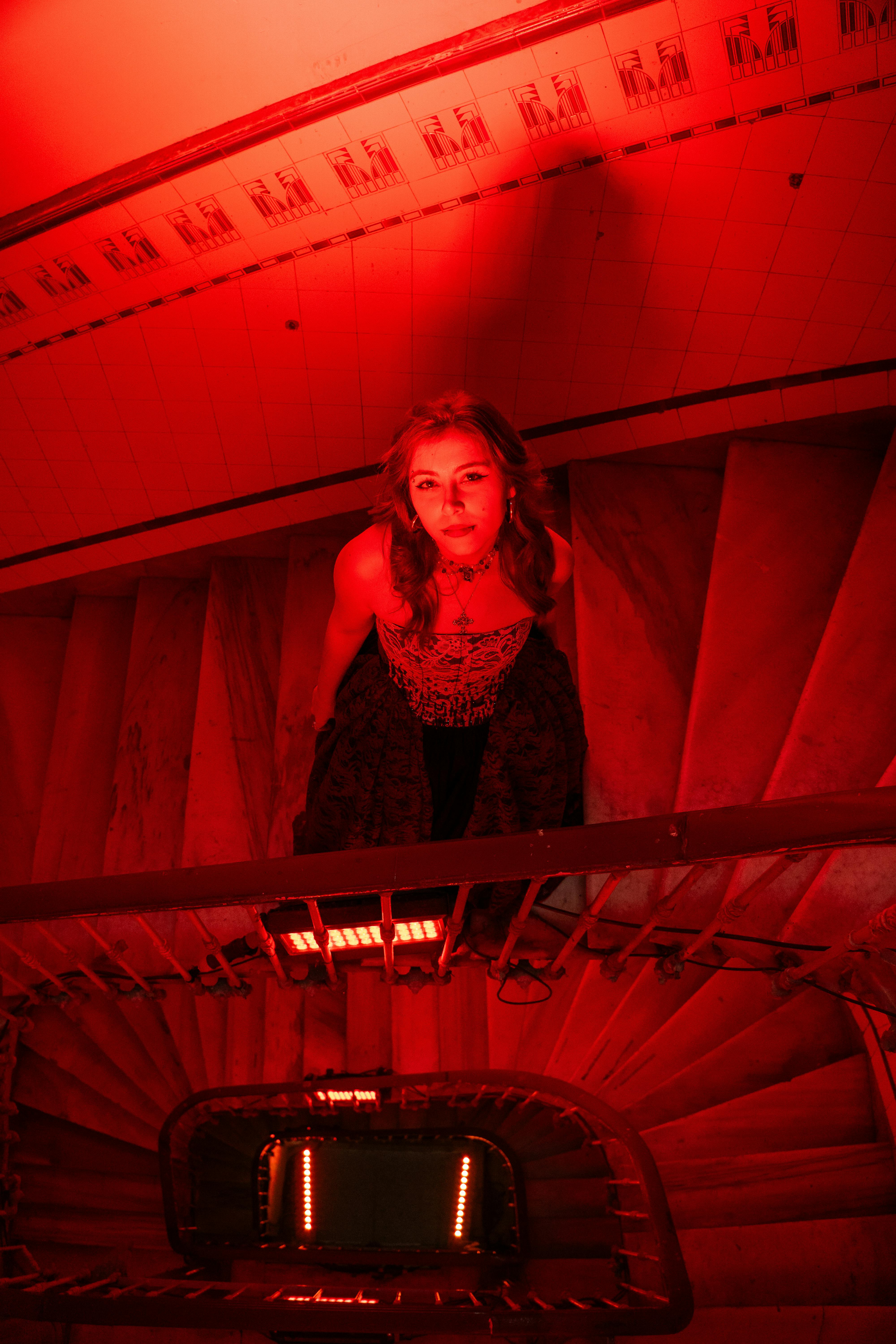 Dramatic Red-Lit Staircase Portrait · Free Stock Photo