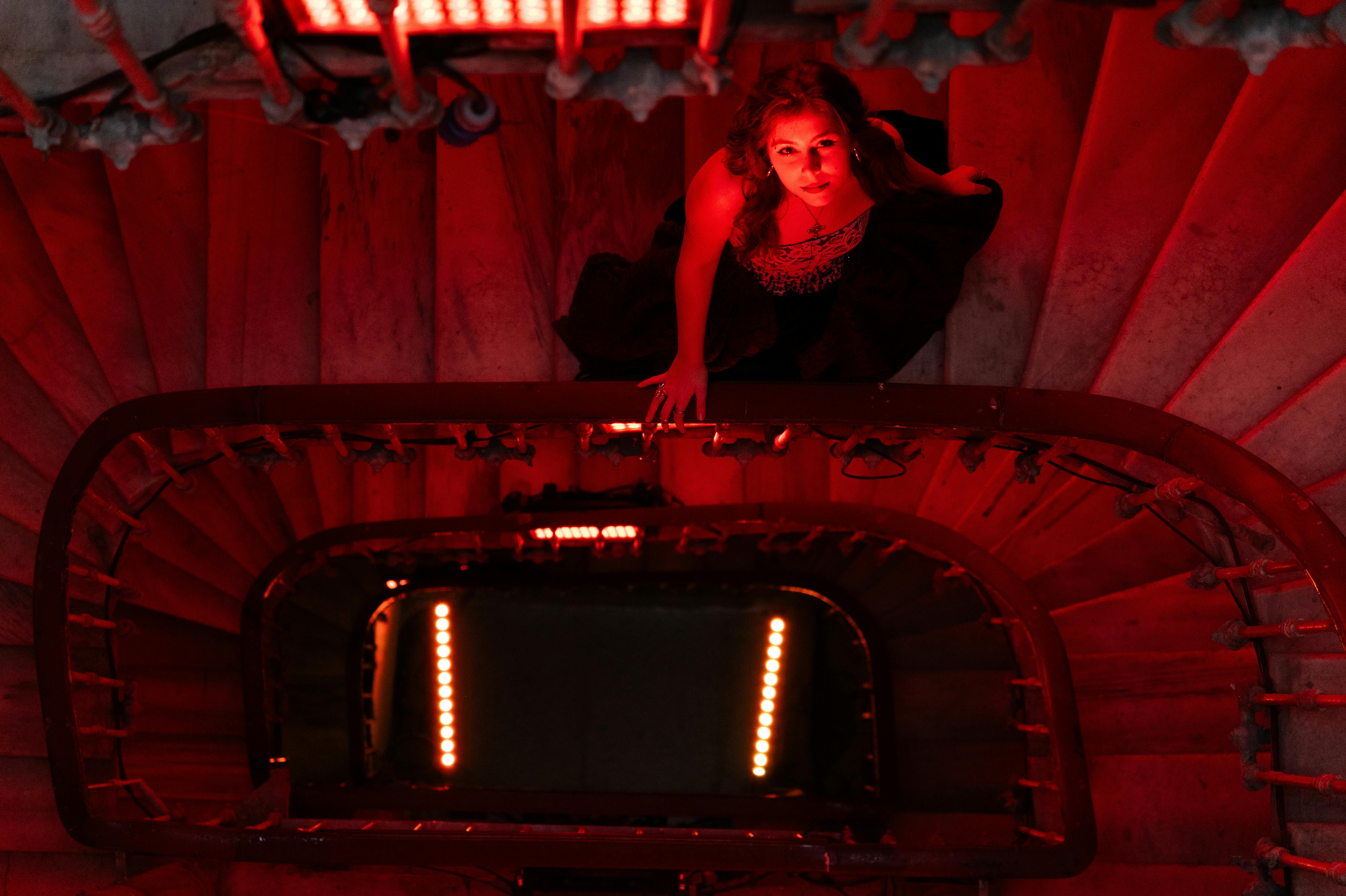 Dramatic Staircase Portrait with Red Lighting · Free Stock Photo