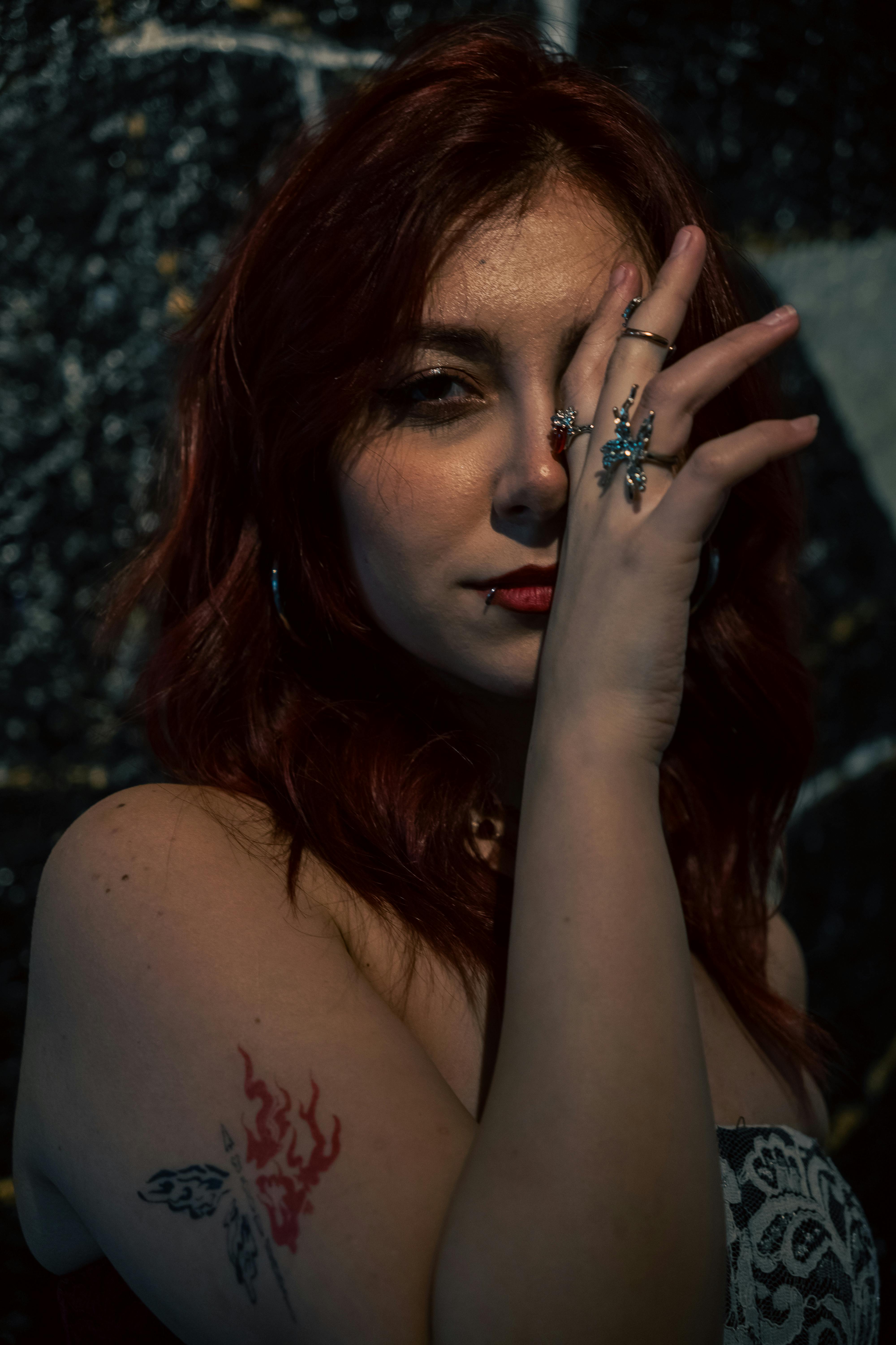 Moody Portrait of Woman with Red Hair and Tattoos · Free Stock Photo