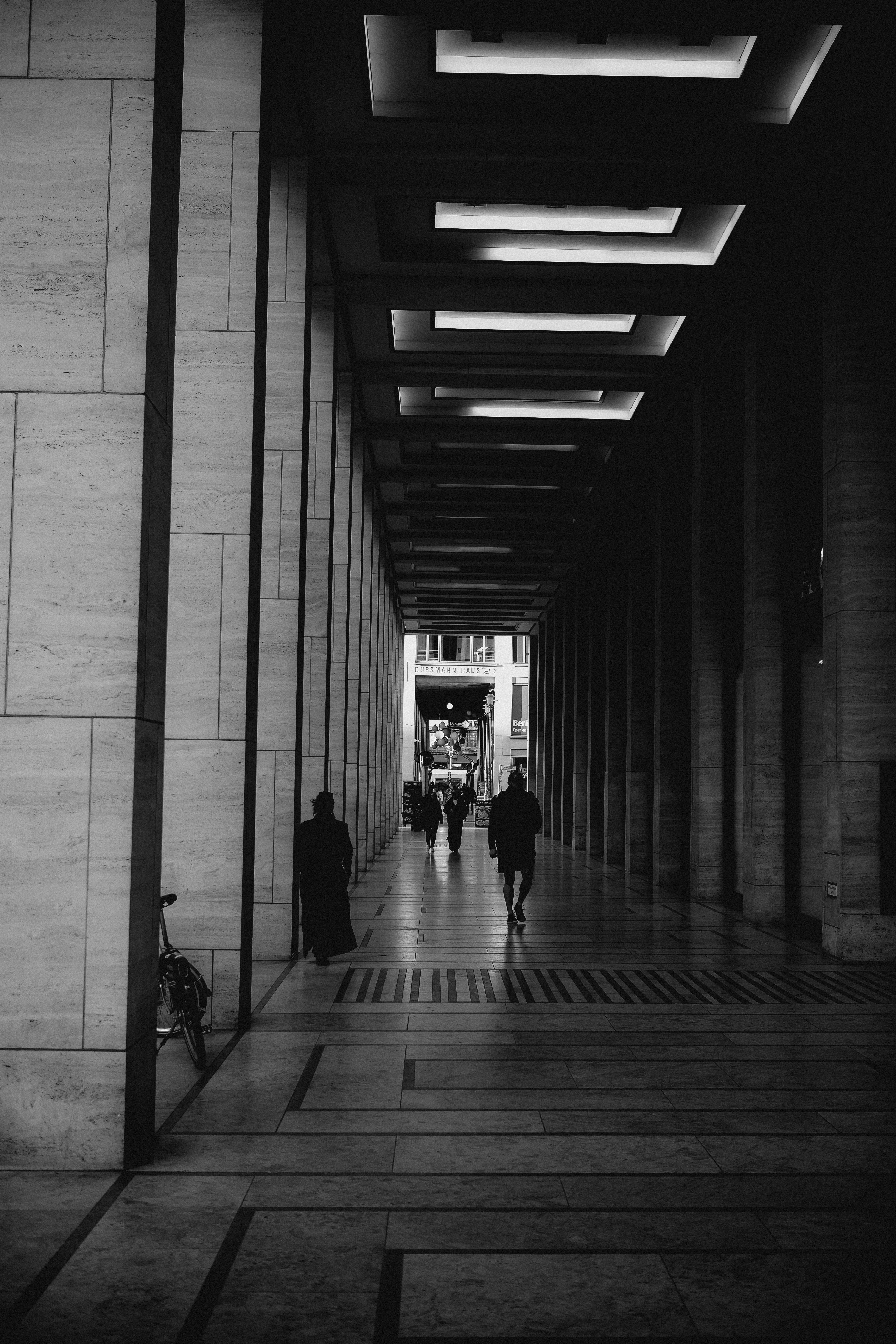 Urban Passage with Silhouetted Figures · Free Stock Photo
