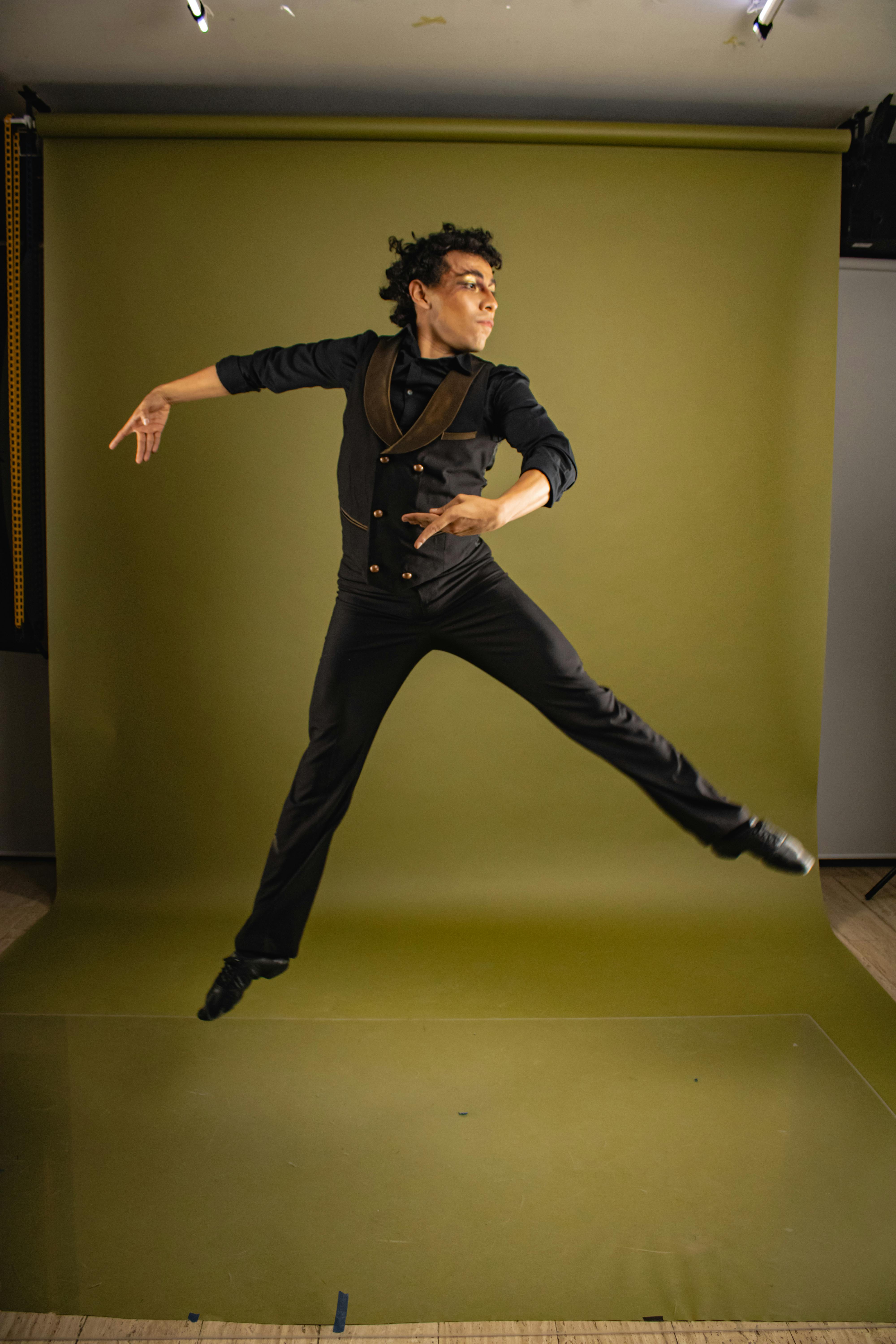 Dynamic male dancer in mid-air leap · Free Stock Photo