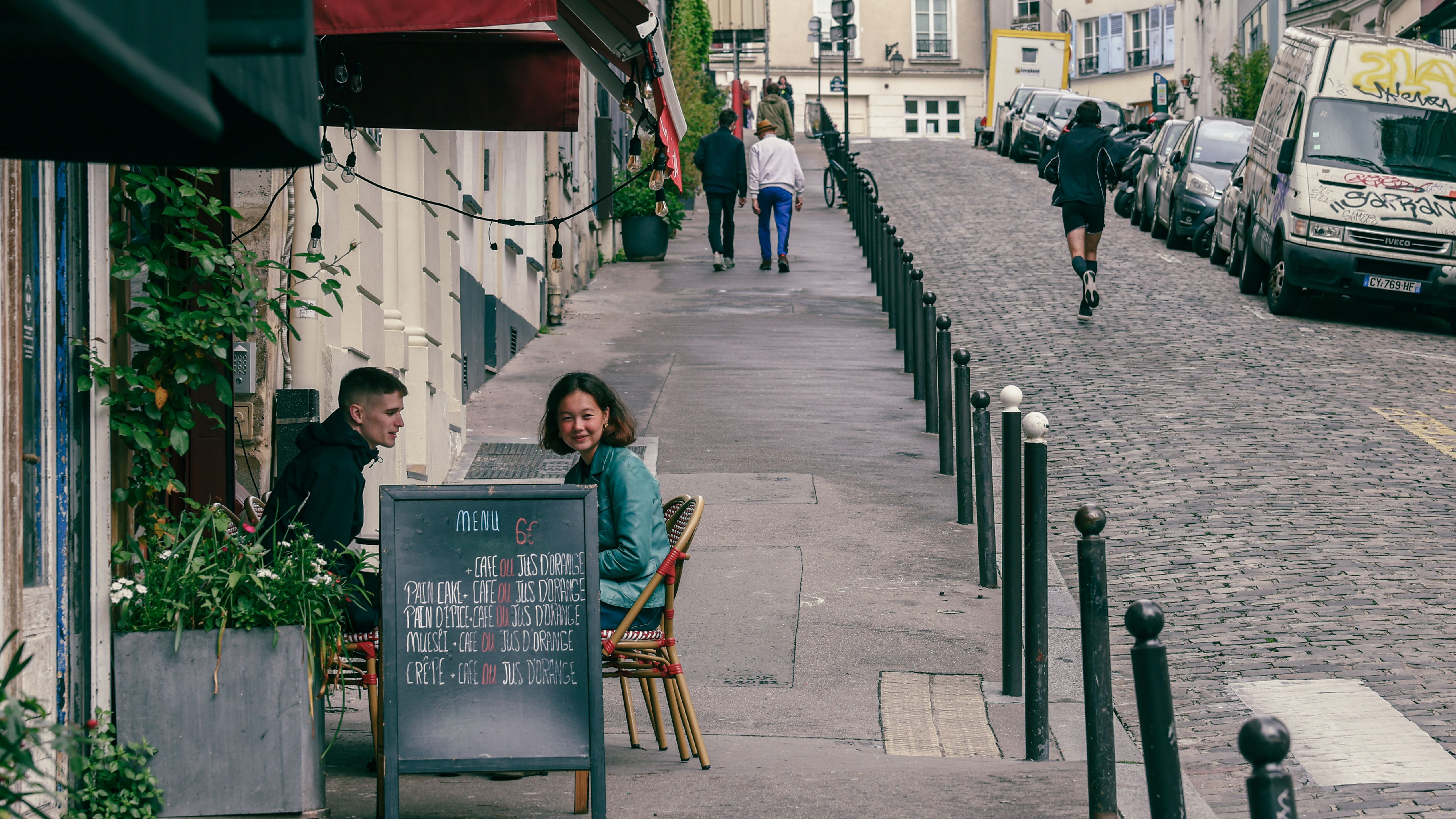 Charming Parisian Street Scene with Cafe and Cobblestone · Free Stock Photo