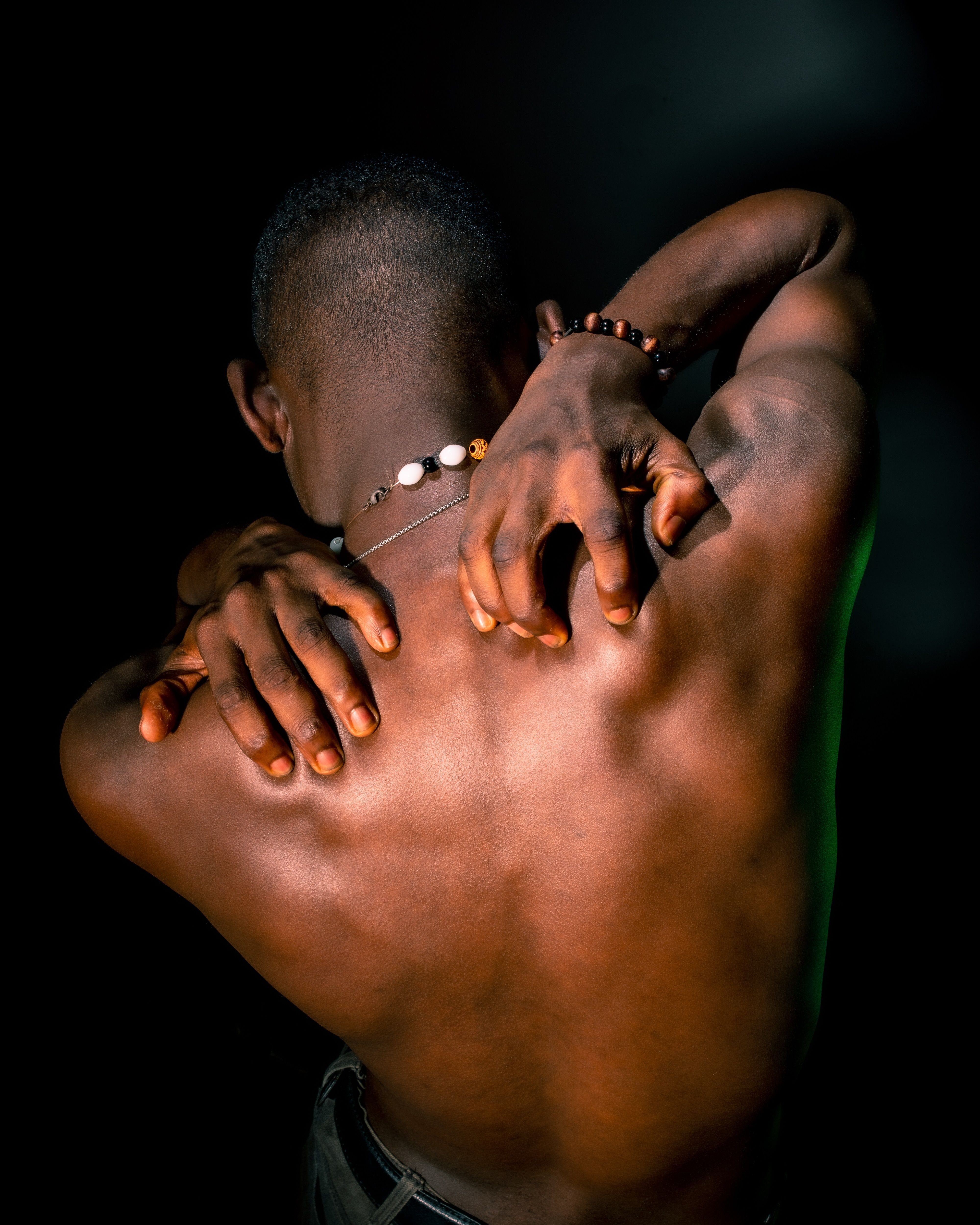 Expressive Shirtless Back Pose in Dramatic Lighting · Free Stock Photo