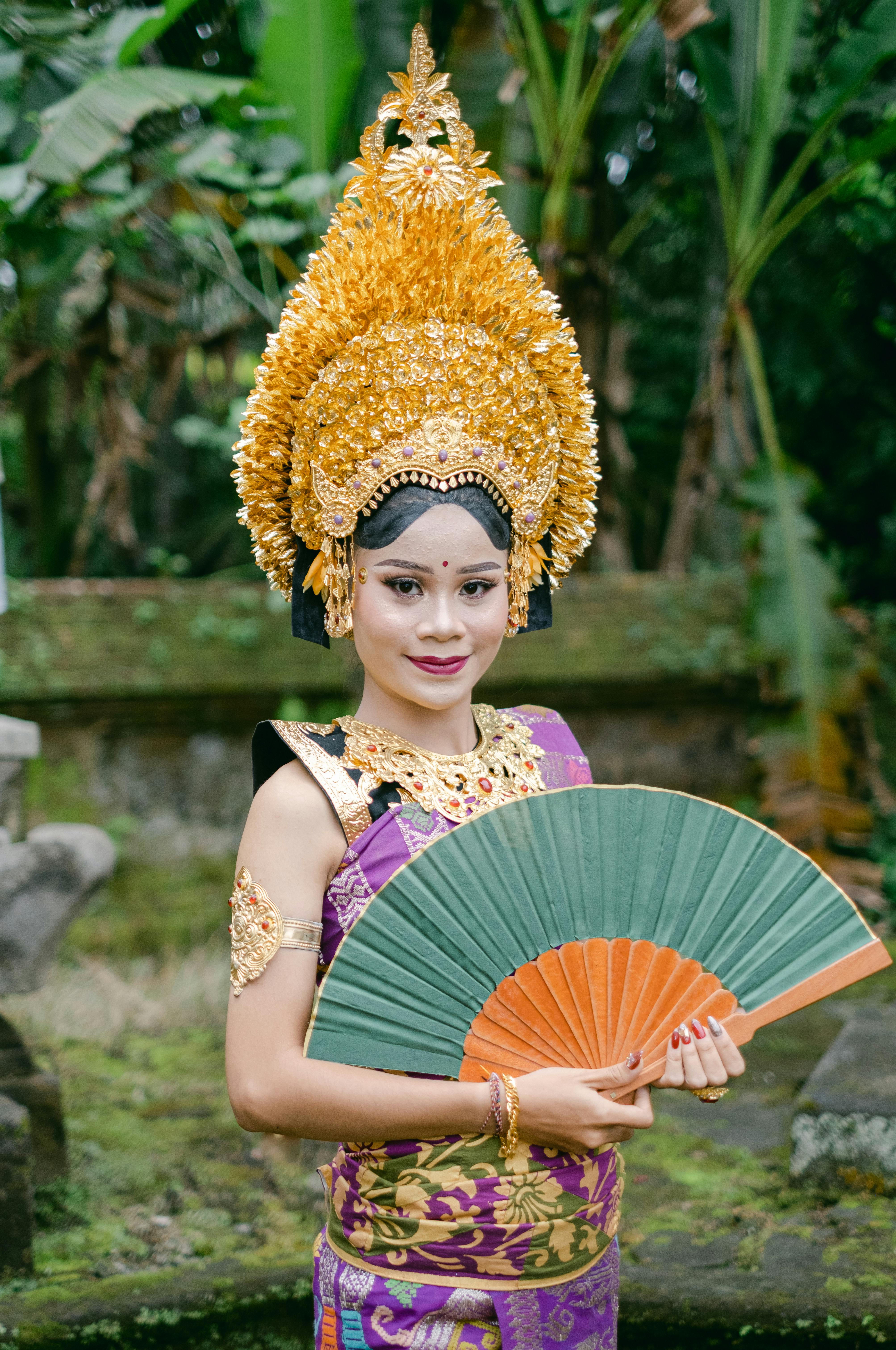 Balinese Traditional Dancer Holding Fan Outdoors · Free Stock Photo