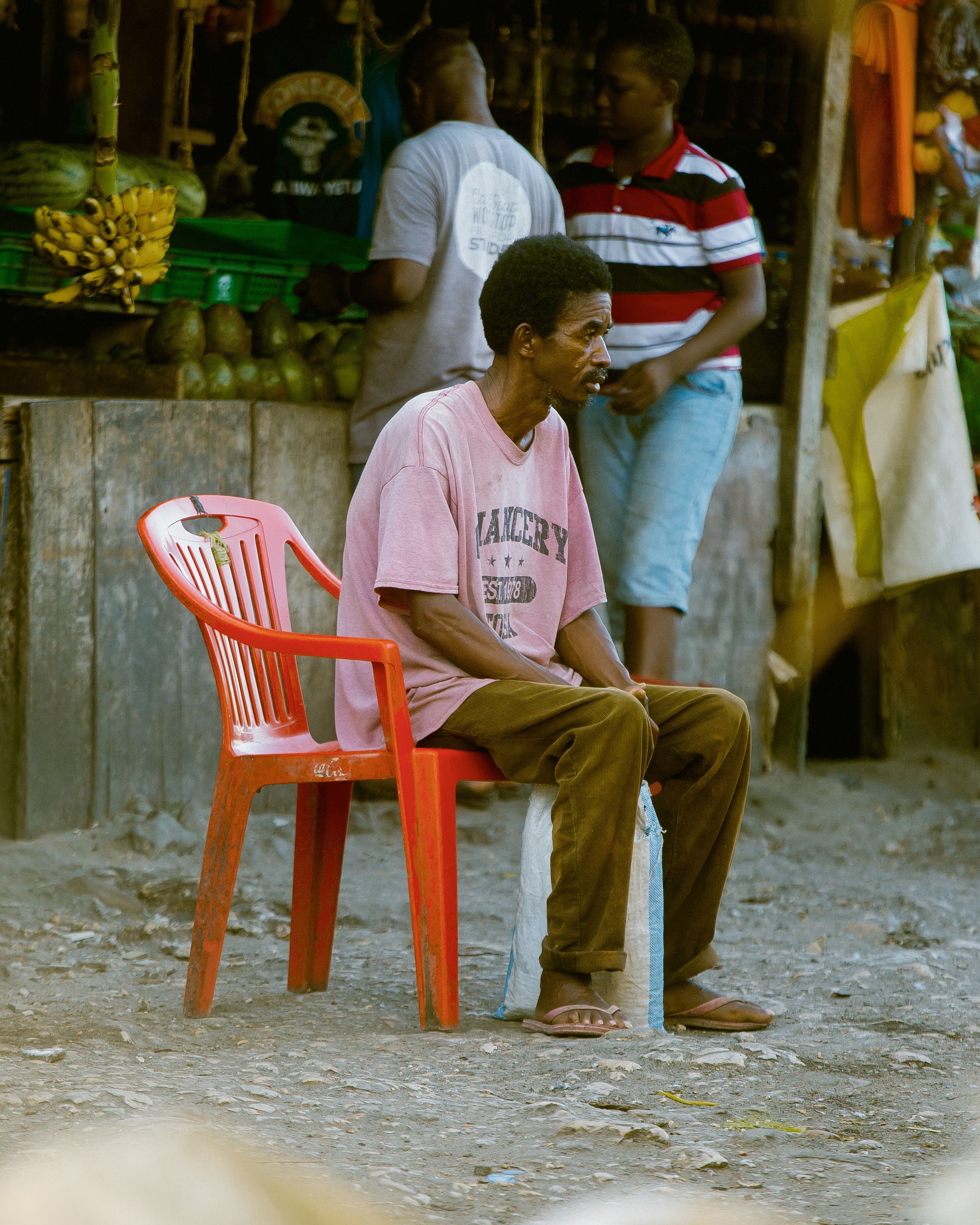 Local Market Scene with Man Seated · Free Stock Photo
