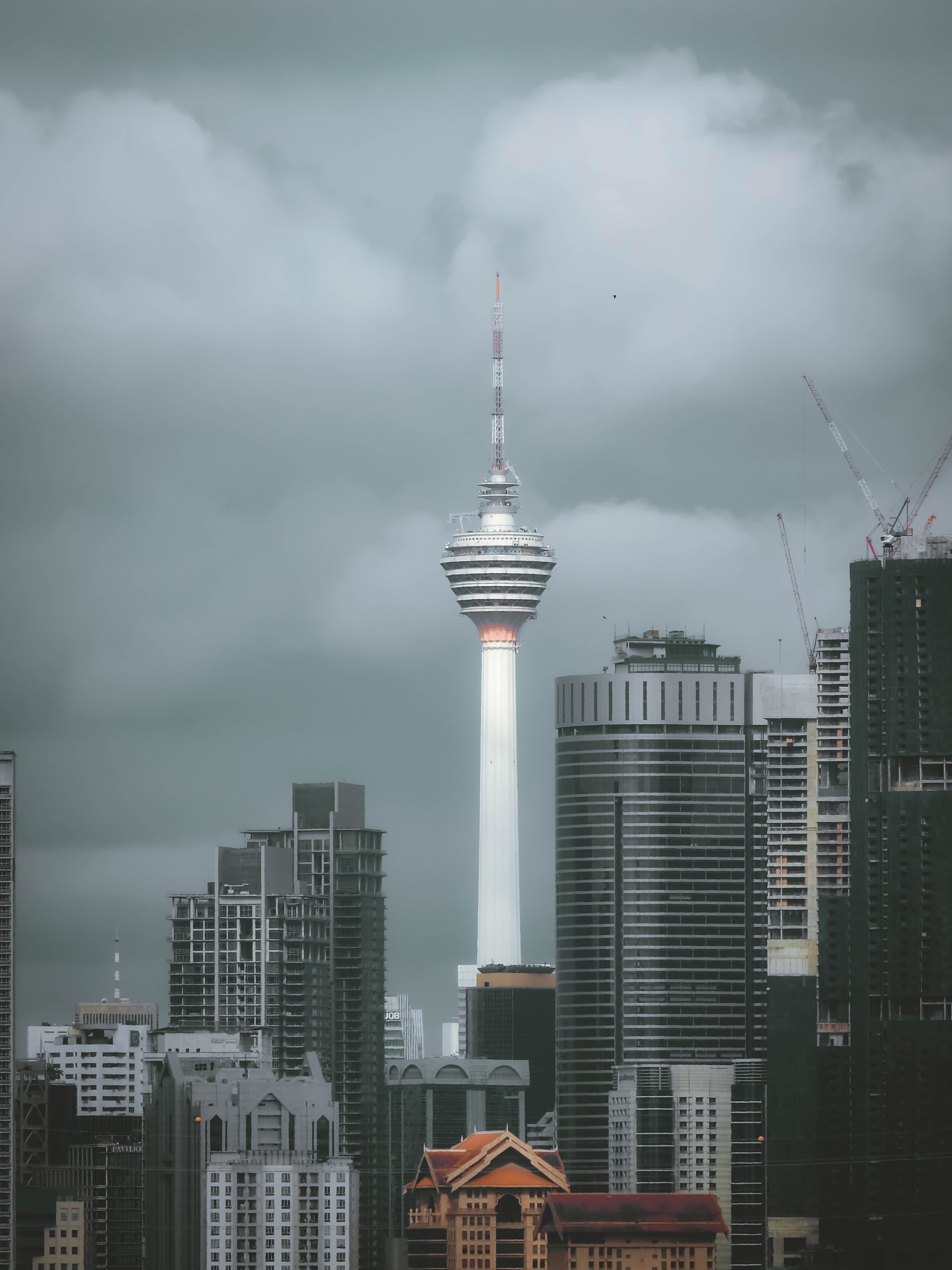 Kuala Lumpur Skyline with KL Tower under Cloudy Skies · Free Stock Photo