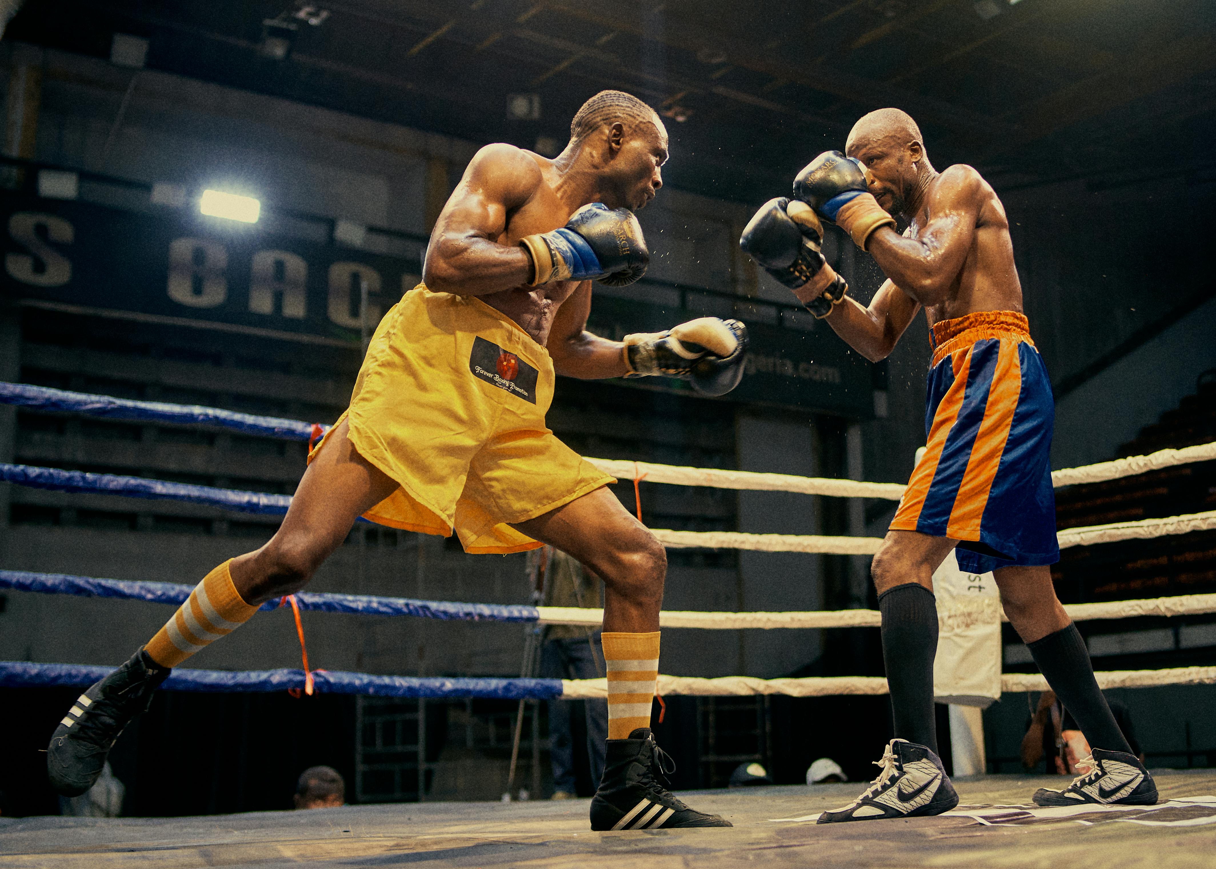 Low-Angle Photo of Two Men Fighting in Boxing Ring · Free Stock Photo