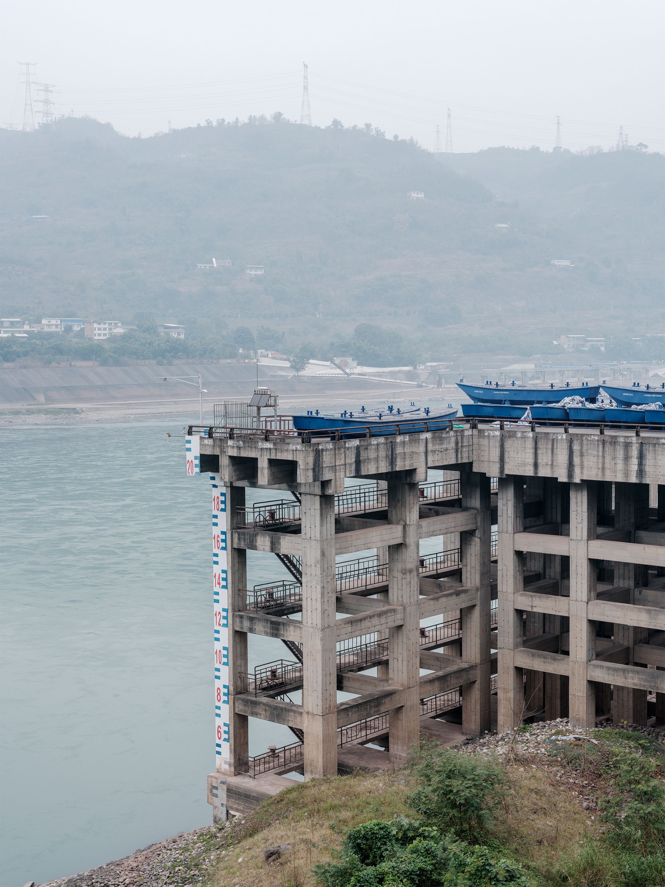 Concrete structure by a serene river in mist · Free Stock Photo
