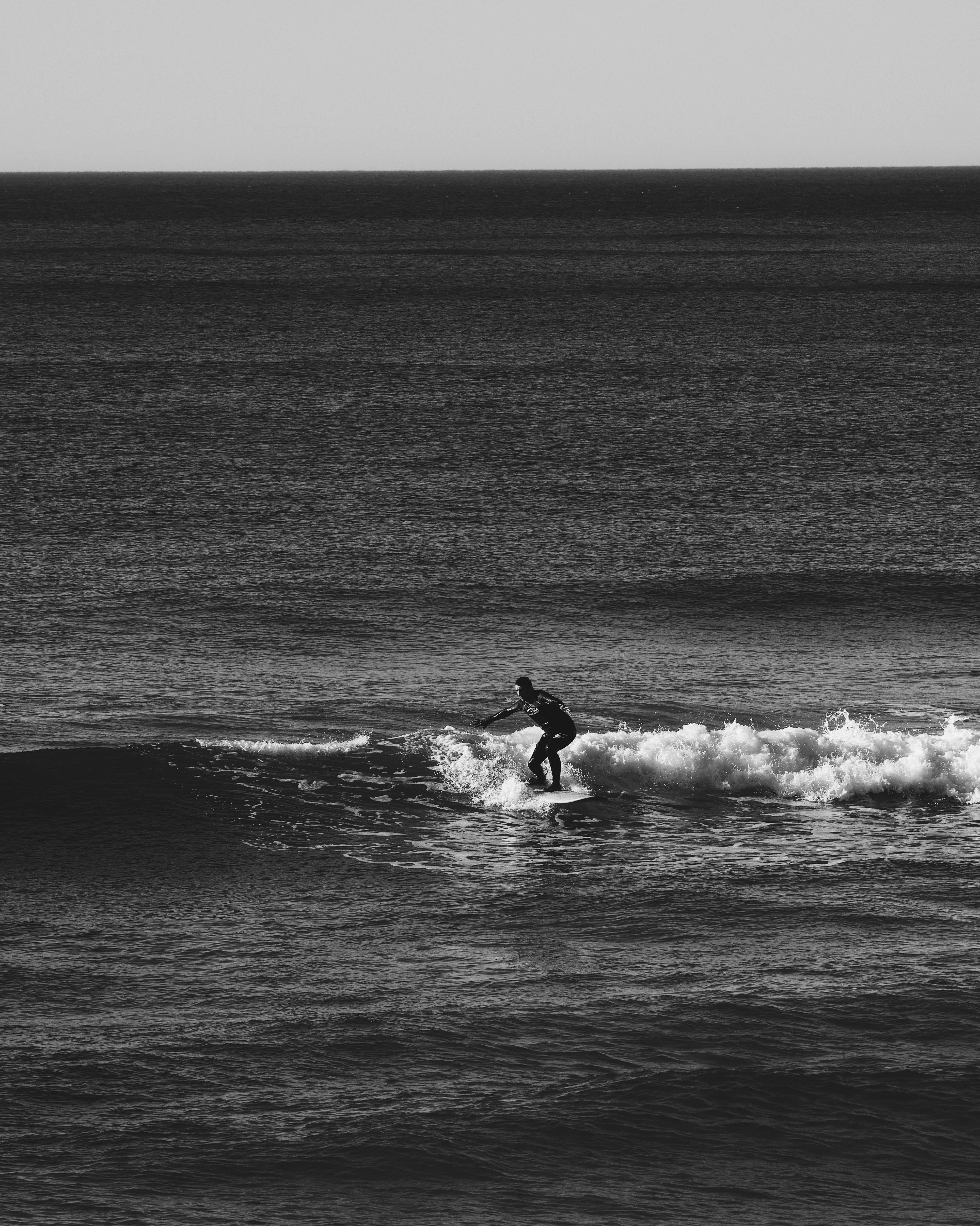 Monochrome Surfer Riding Waves in Florianópolis · Free Stock Photo