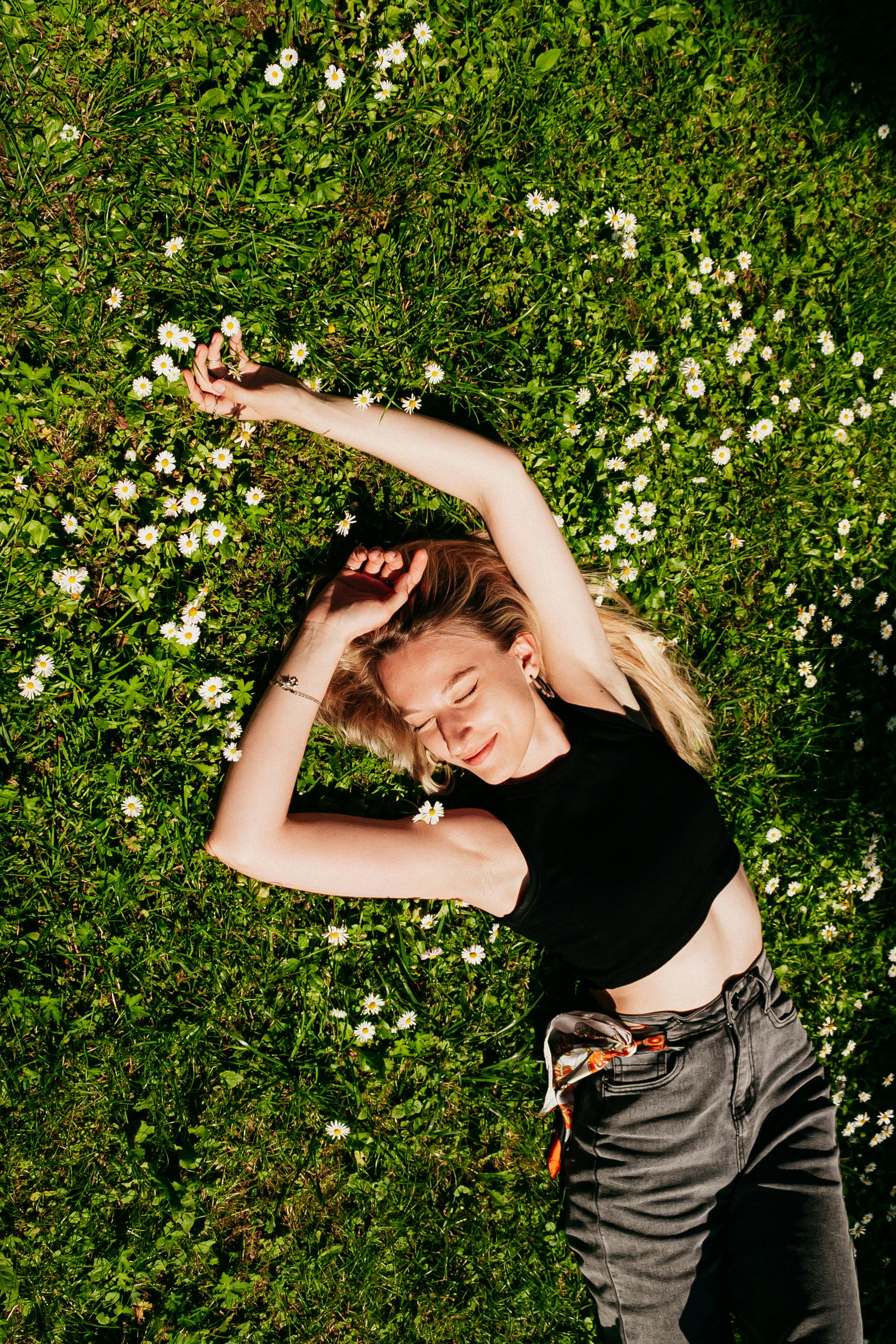 Young Woman Relaxing on a Floral Meadow · Free Stock Photo