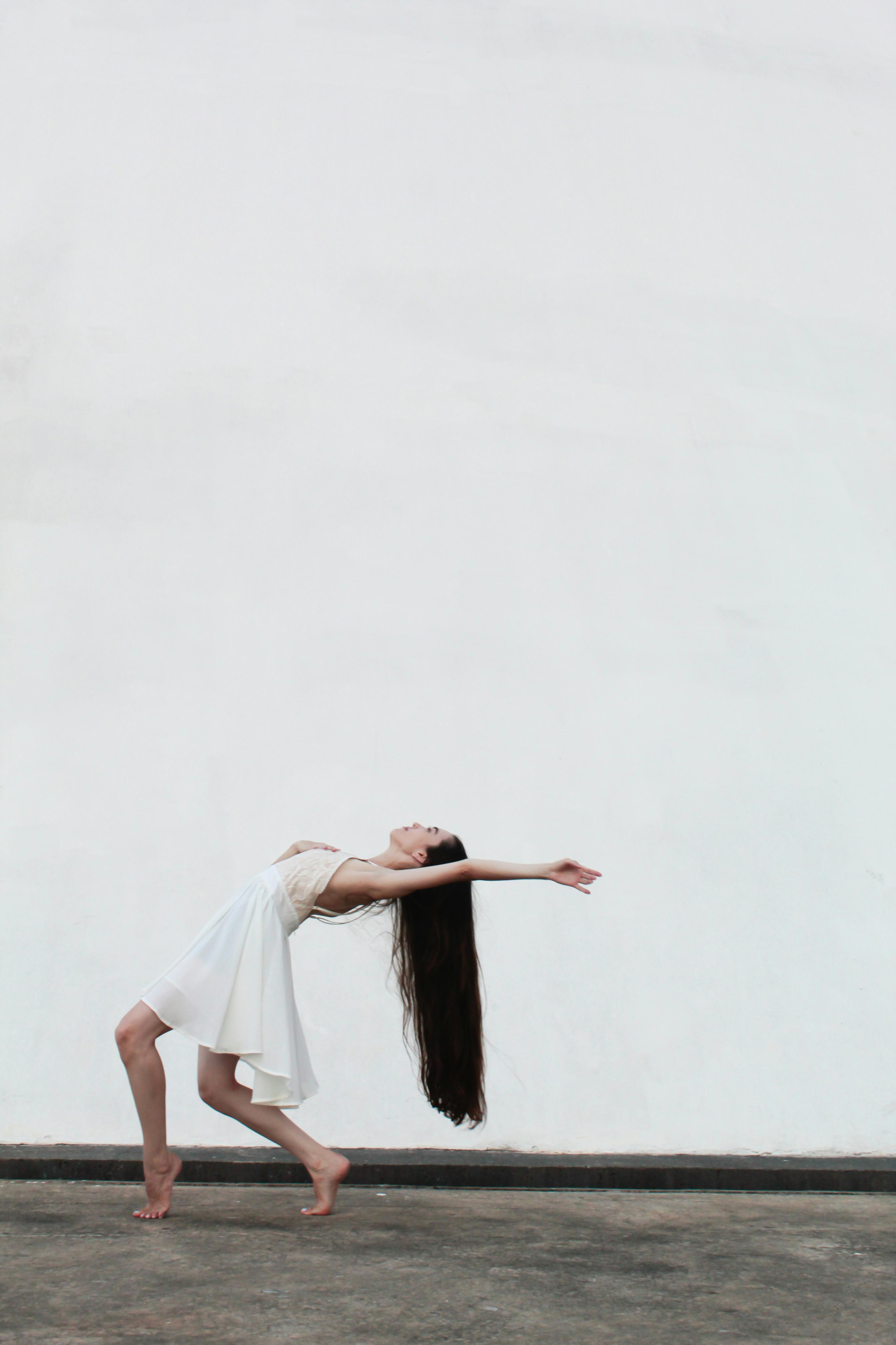 Graceful Dance Pose Against Minimalist Background · Free Stock Photo