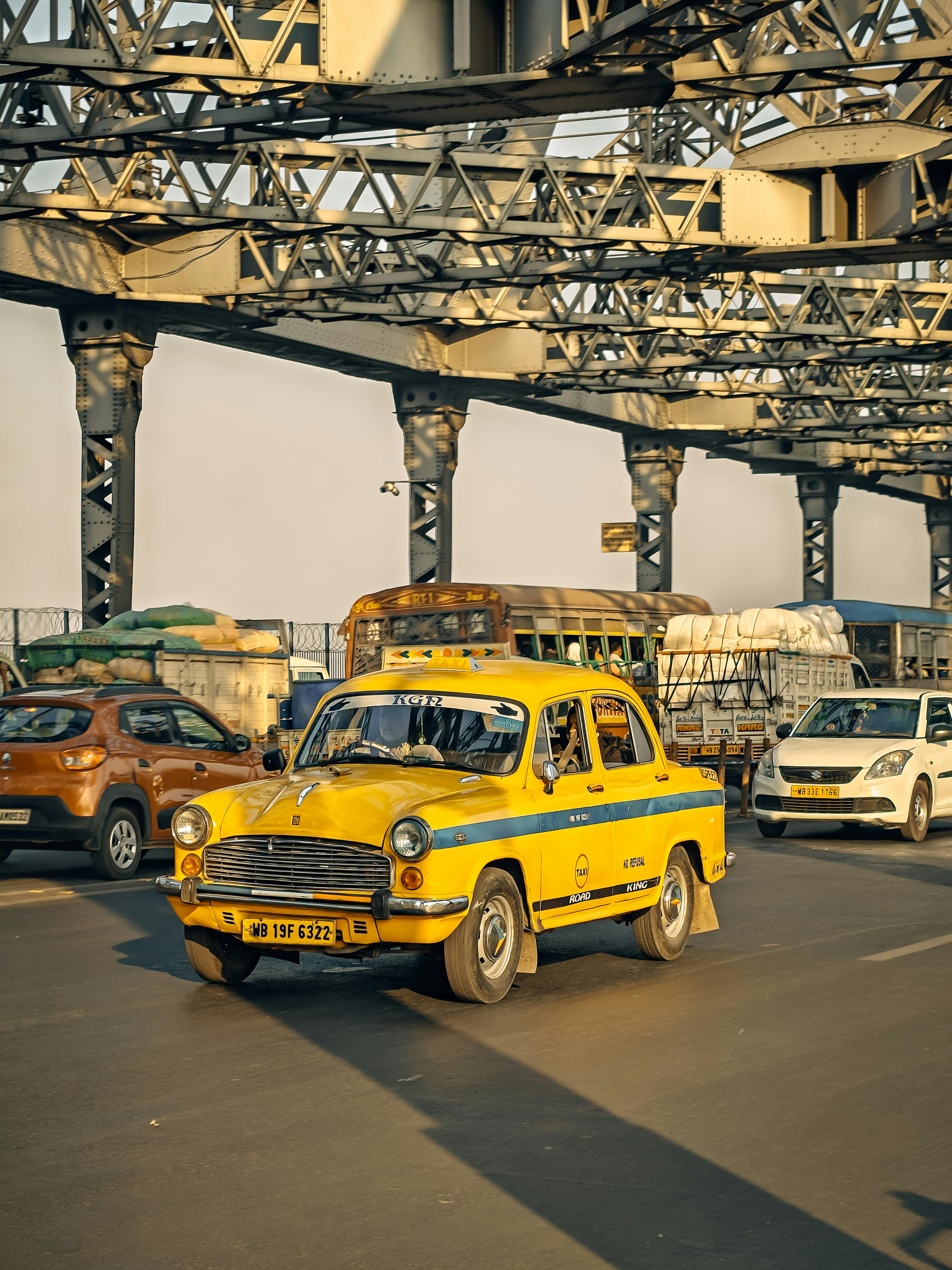 Iconic Yellow Taxi on Howrah Bridge in Kolkata · Free Stock Photo