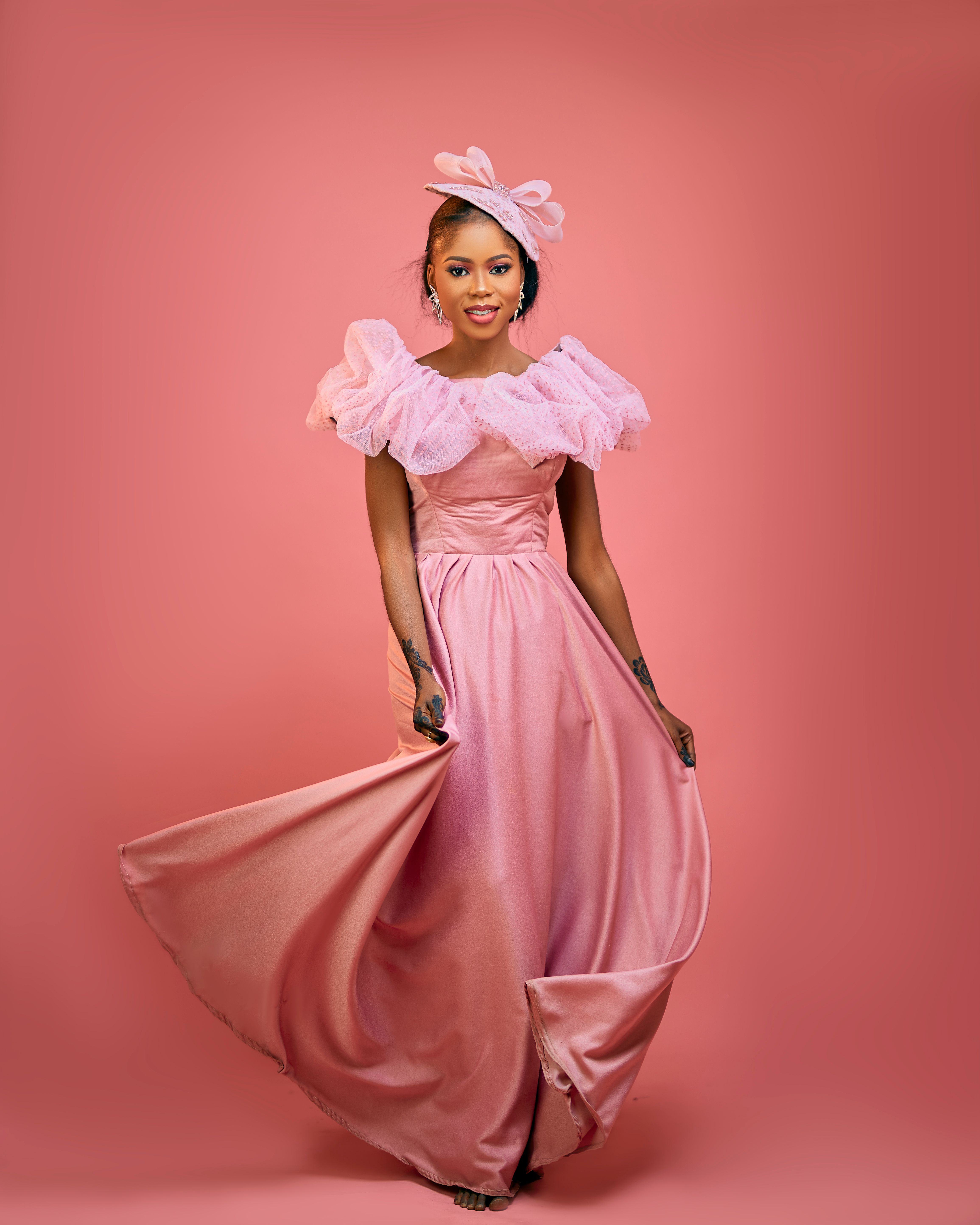 Elegant Woman in Pink Formal Gown on Studio Background · Free Stock Photo