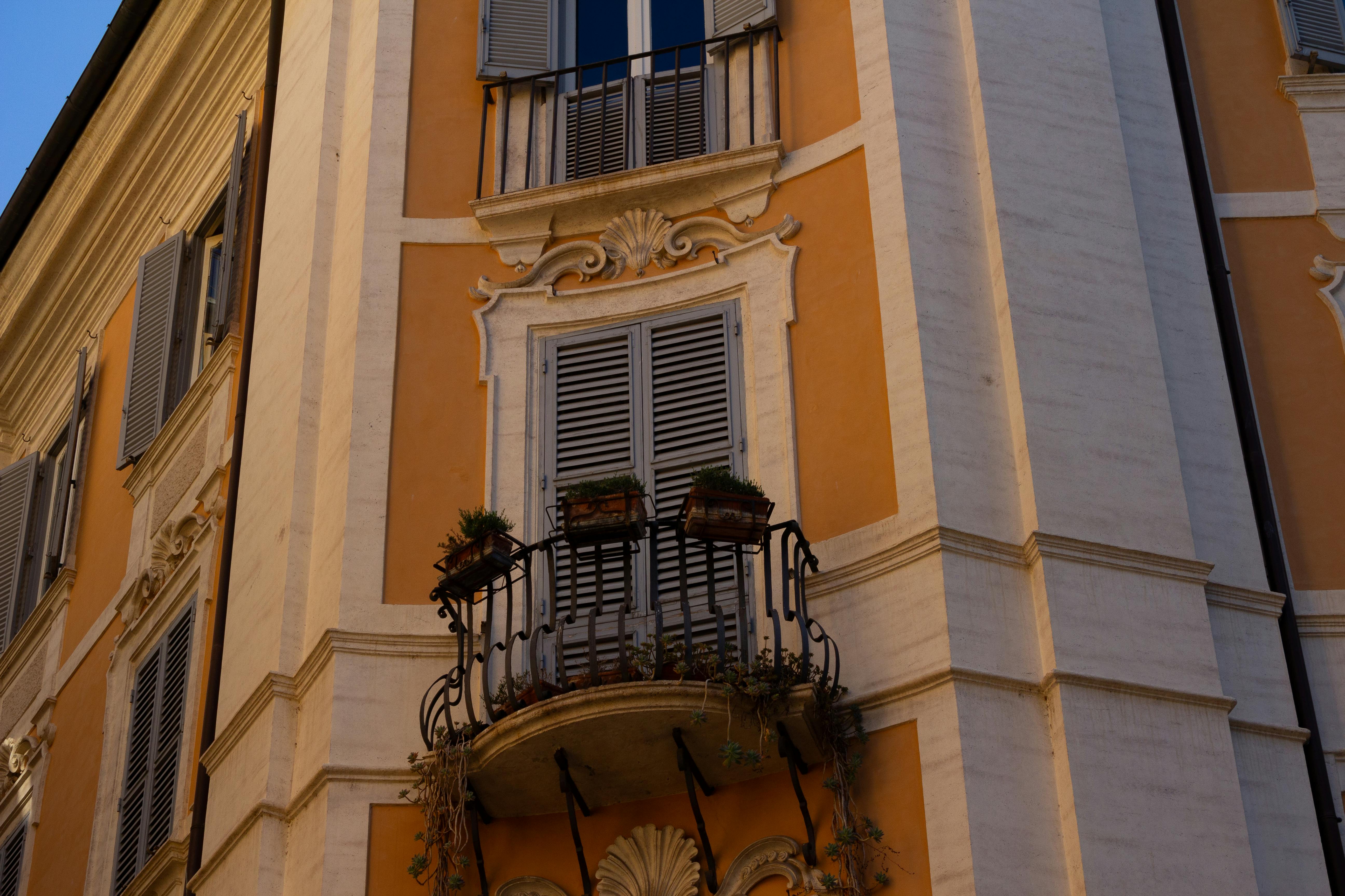 Elegant European Balcony with Rustic Shutters · Free Stock Photo