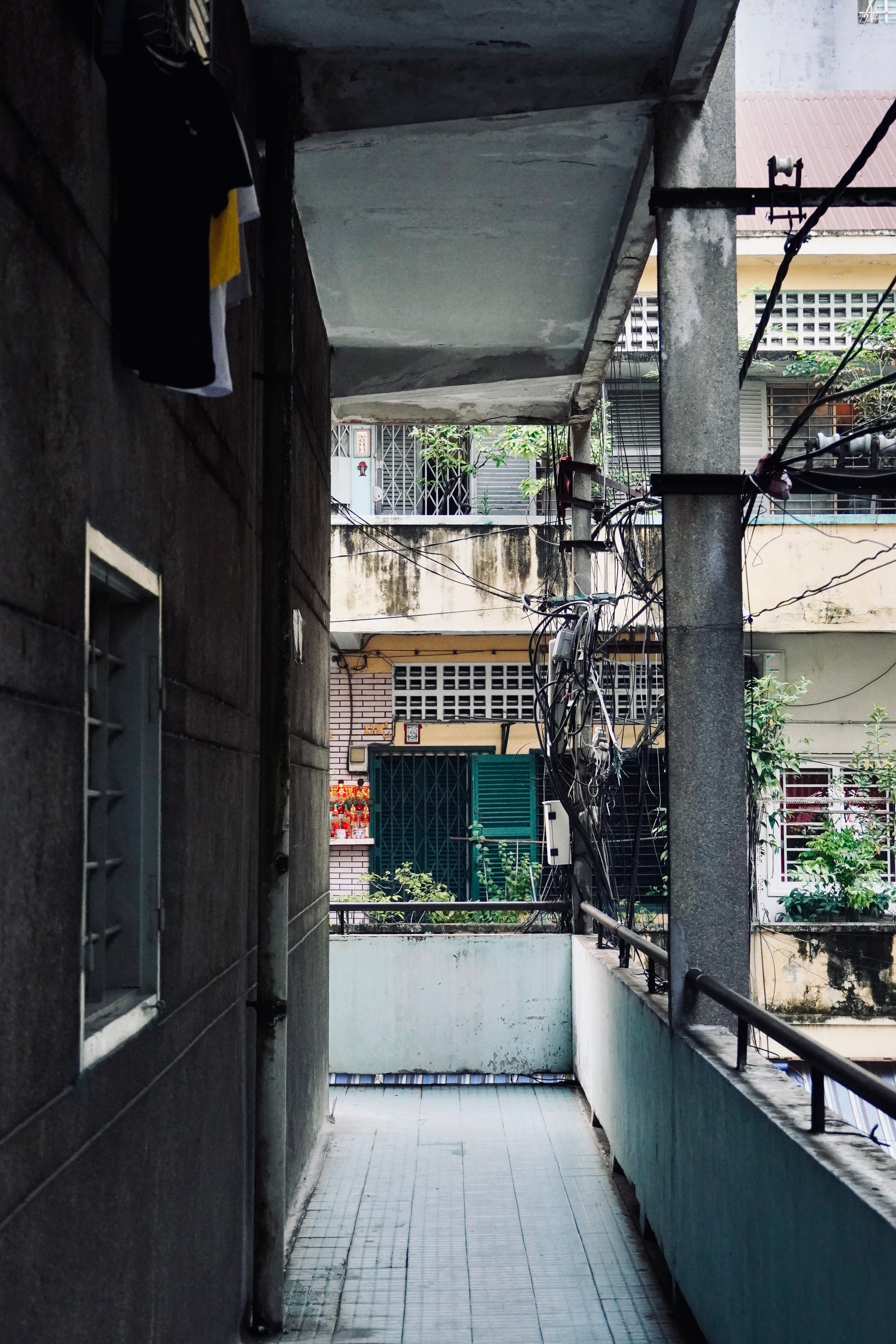 Urban Apartment Corridor with Overhead Wiring · Free Stock Photo