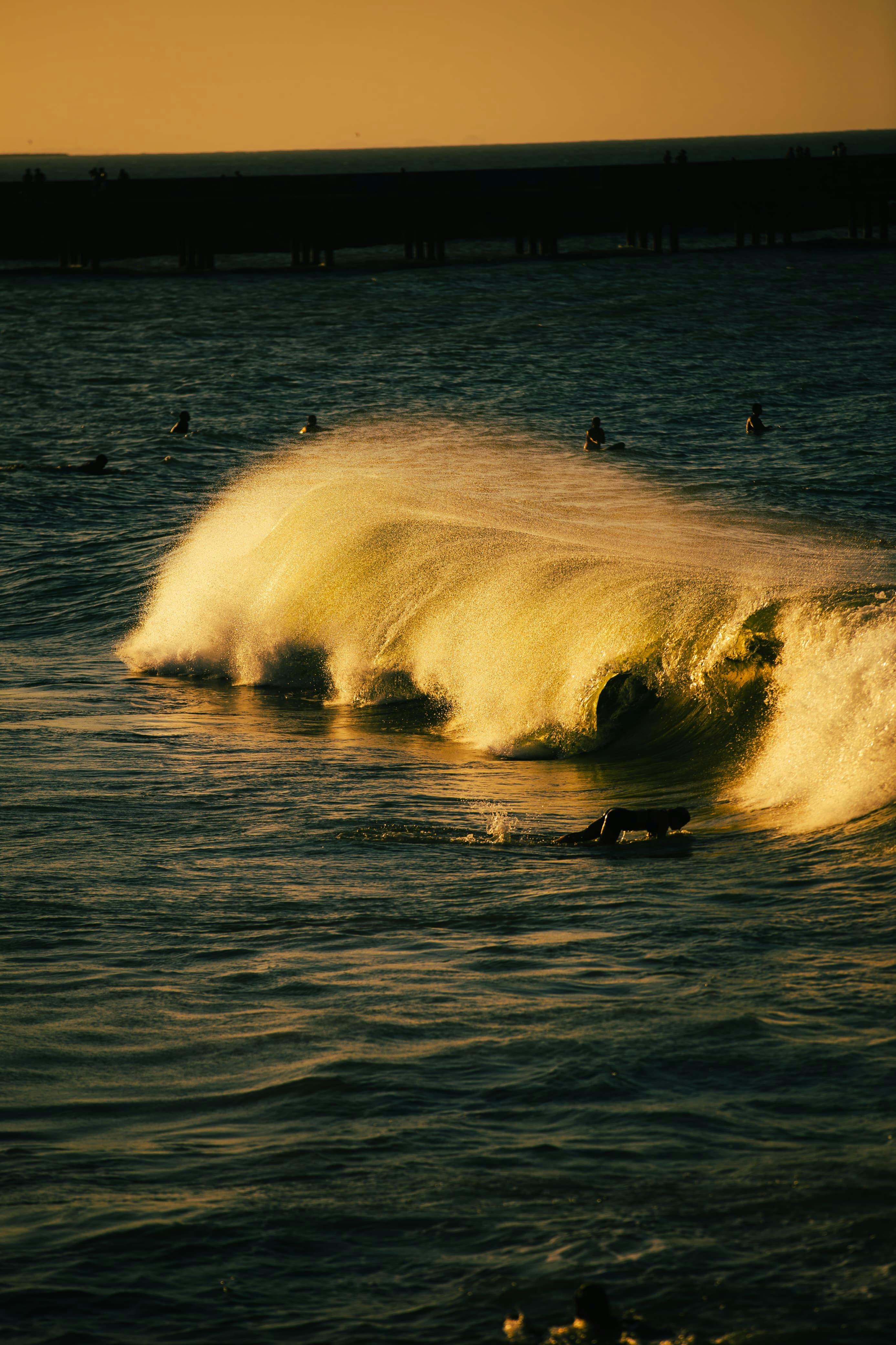 Man Surfing on Sea Waves during Sunset · Free Stock Photo