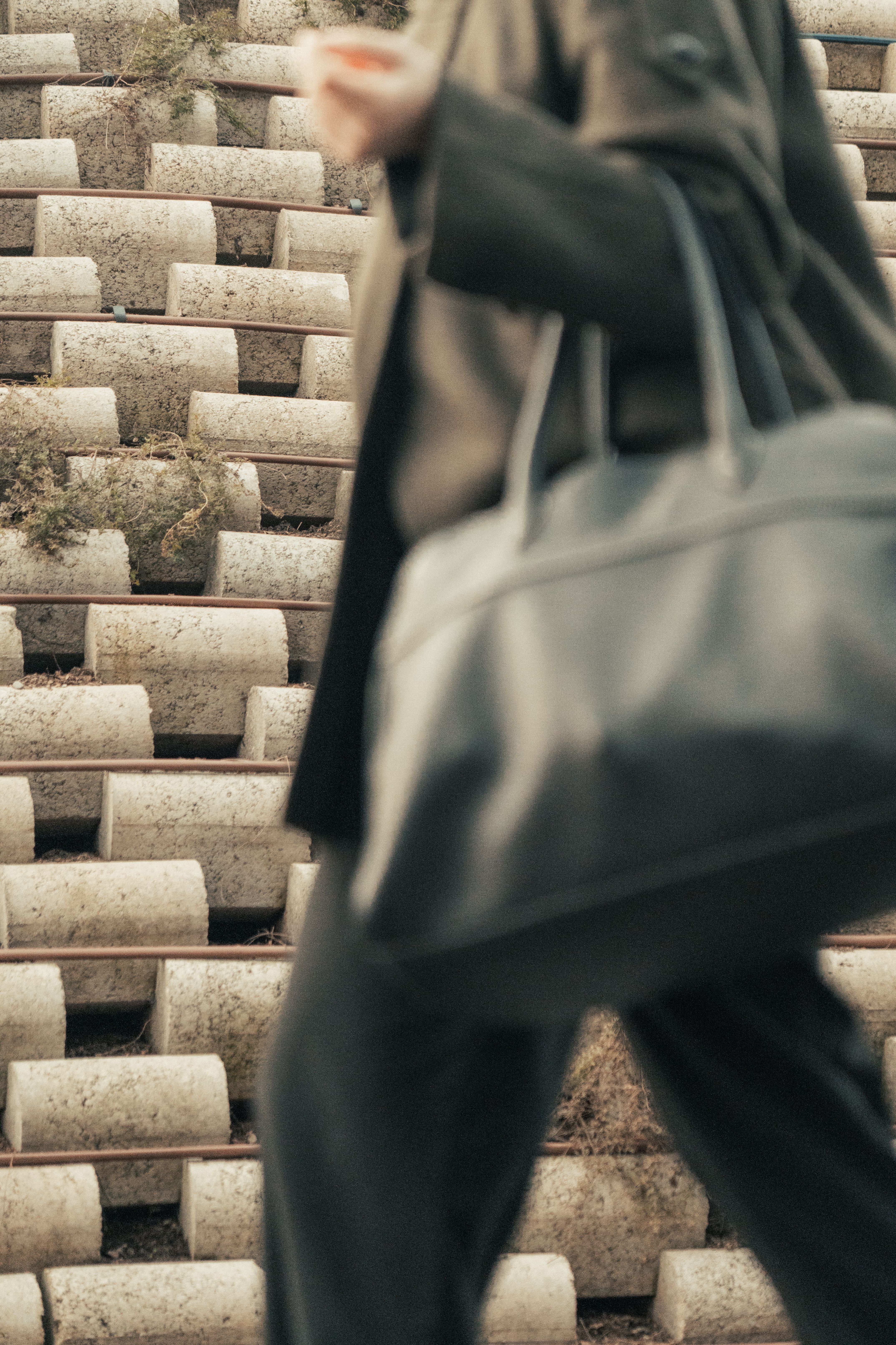 Blurred Motion of Person Walking Past Stone Wall · Free Stock Photo