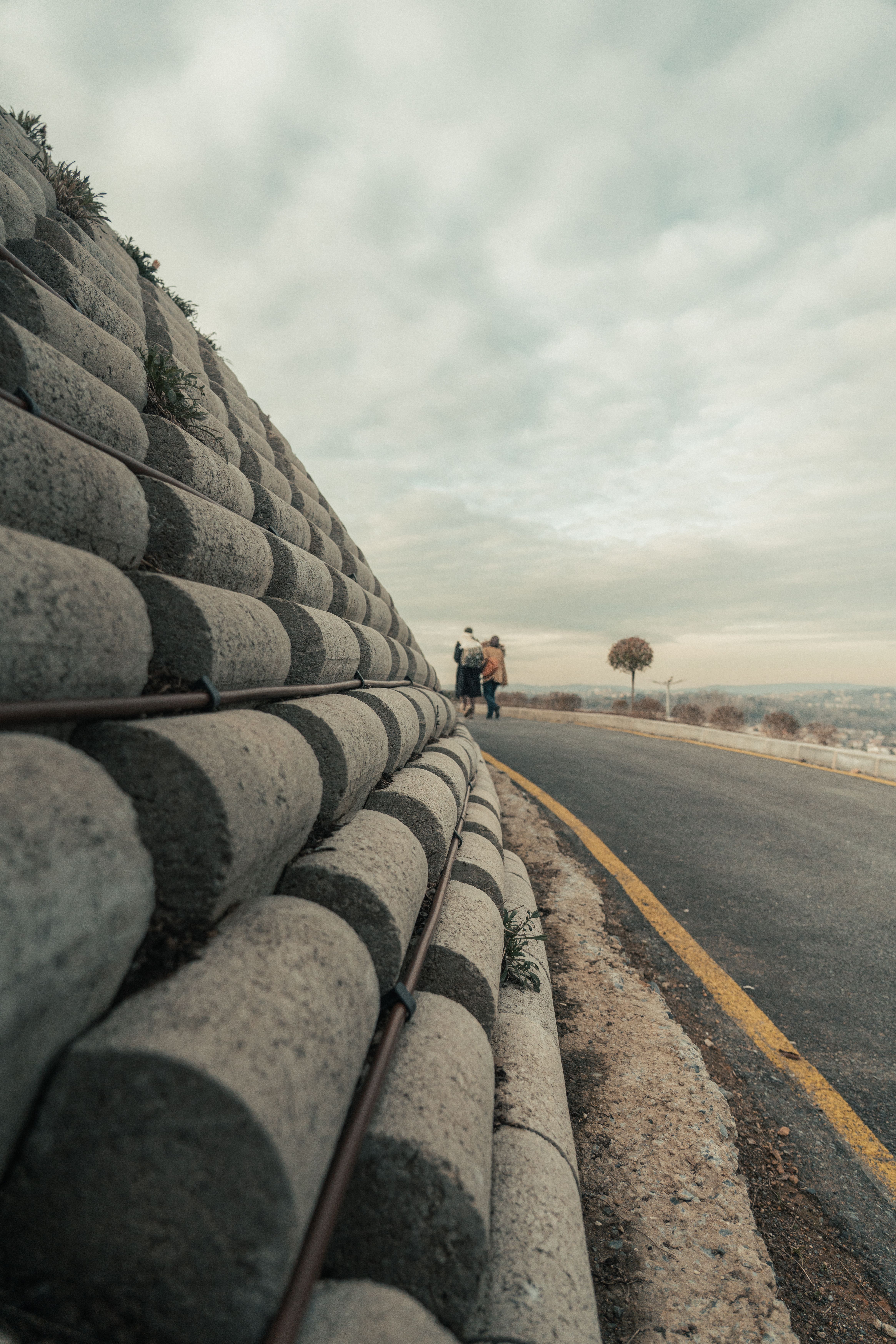 Roadside Perspective with Textured Concrete Wall · Free Stock Photo