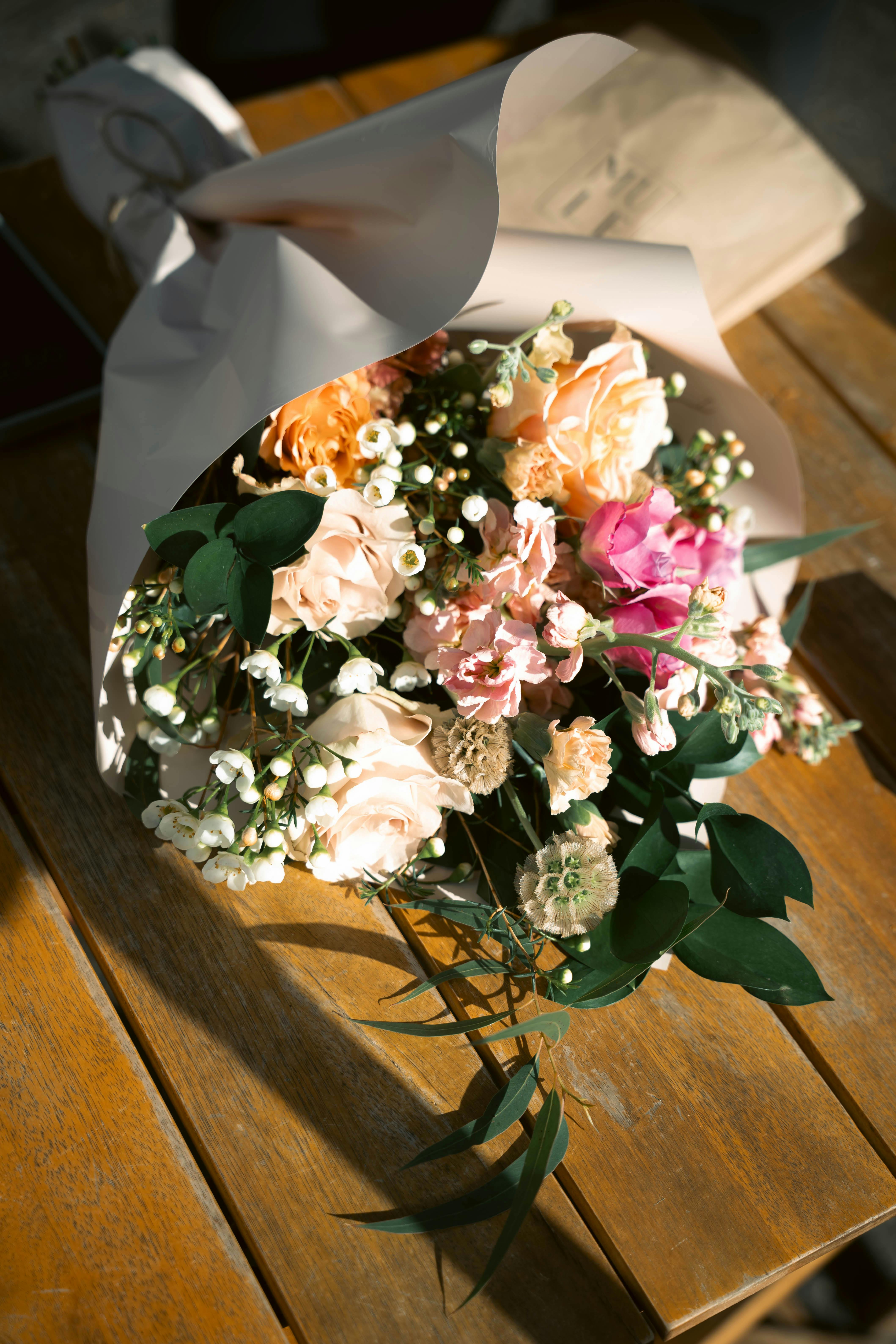 Elegant Bouquet of Mixed Flowers on Wooden Table · Free Stock Photo
