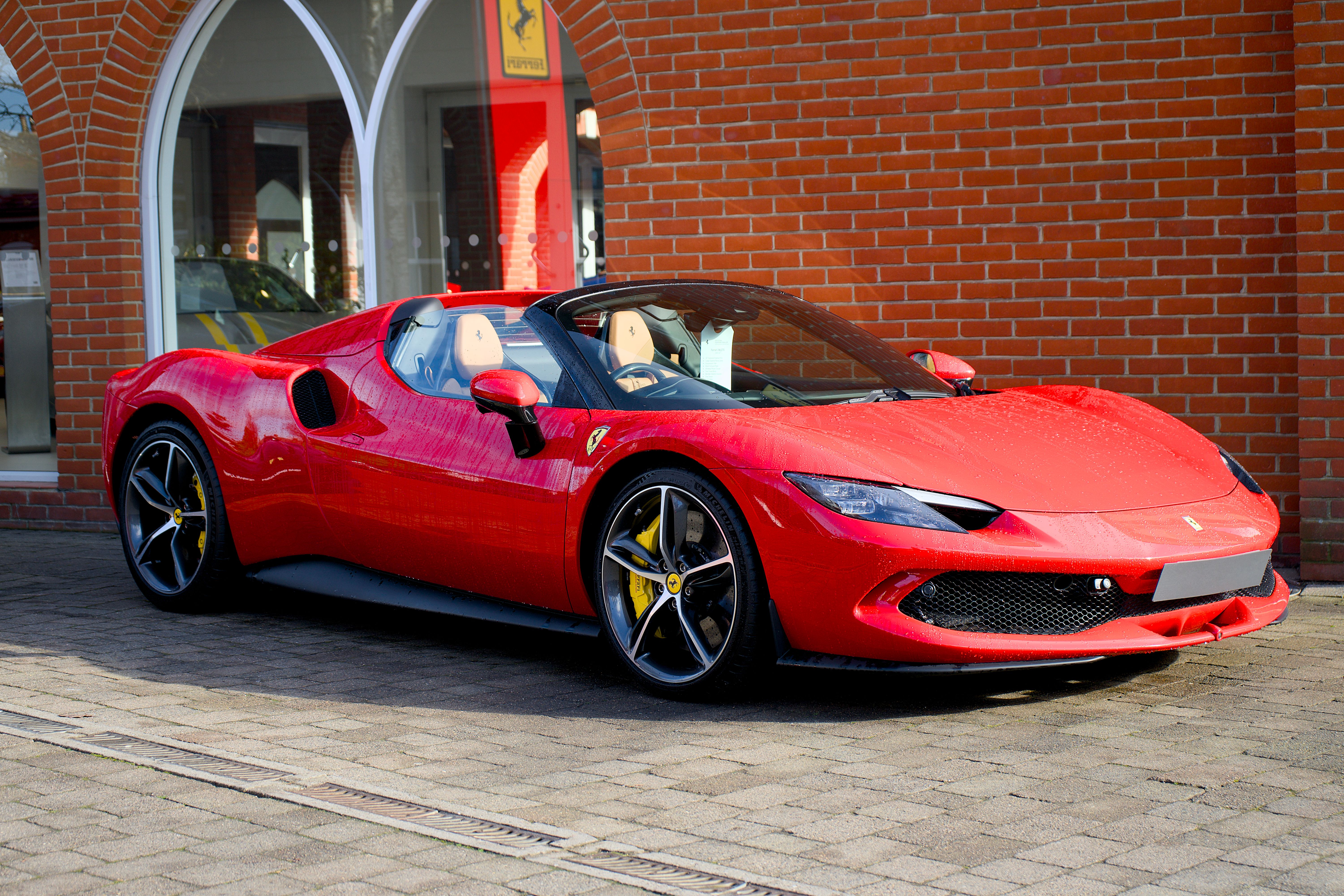 Red Ferrari Sports Car Parked in Front of Building · Free Stock Photo