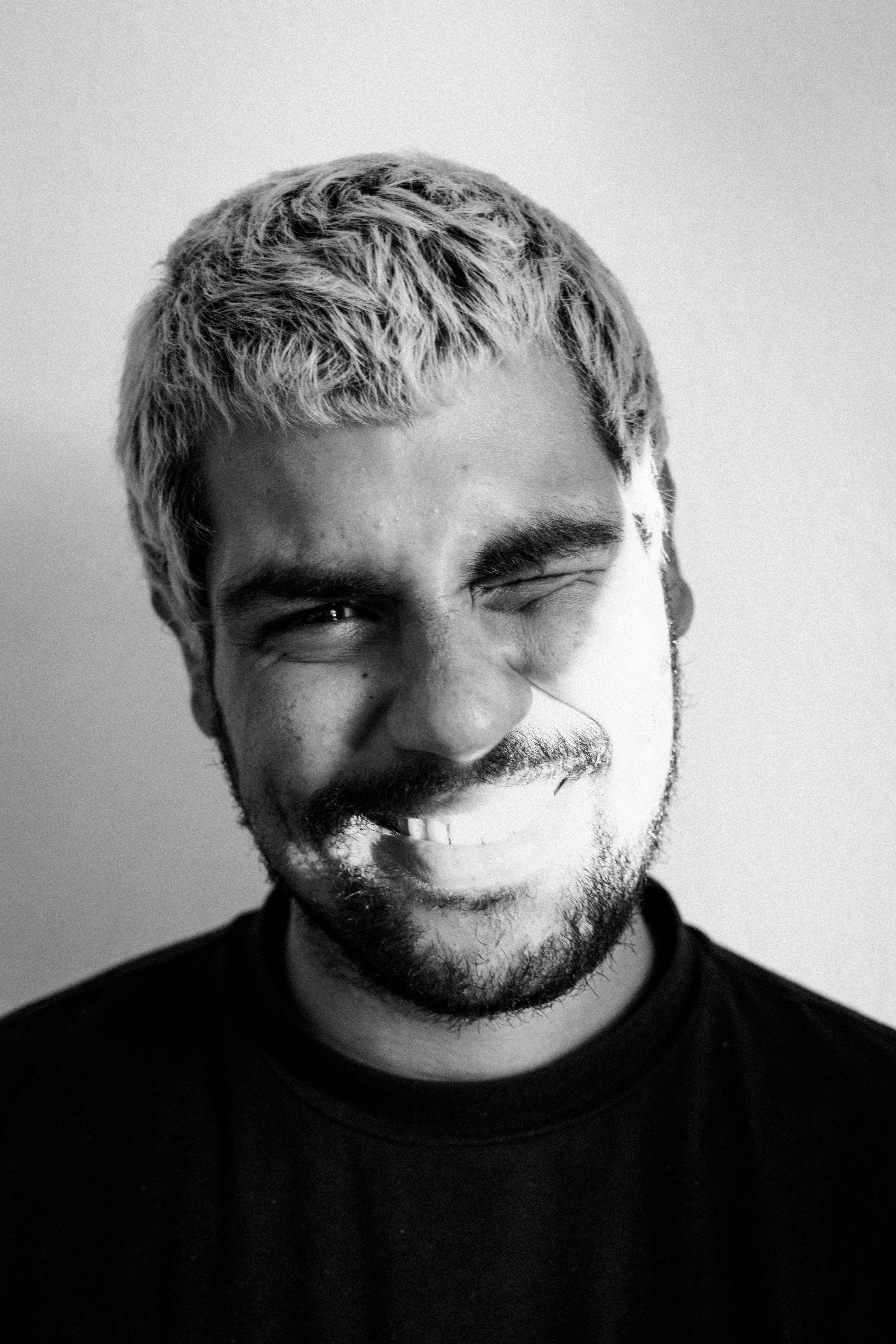 Black and White Portrait of Smiling Man Winking · Free Stock Photo