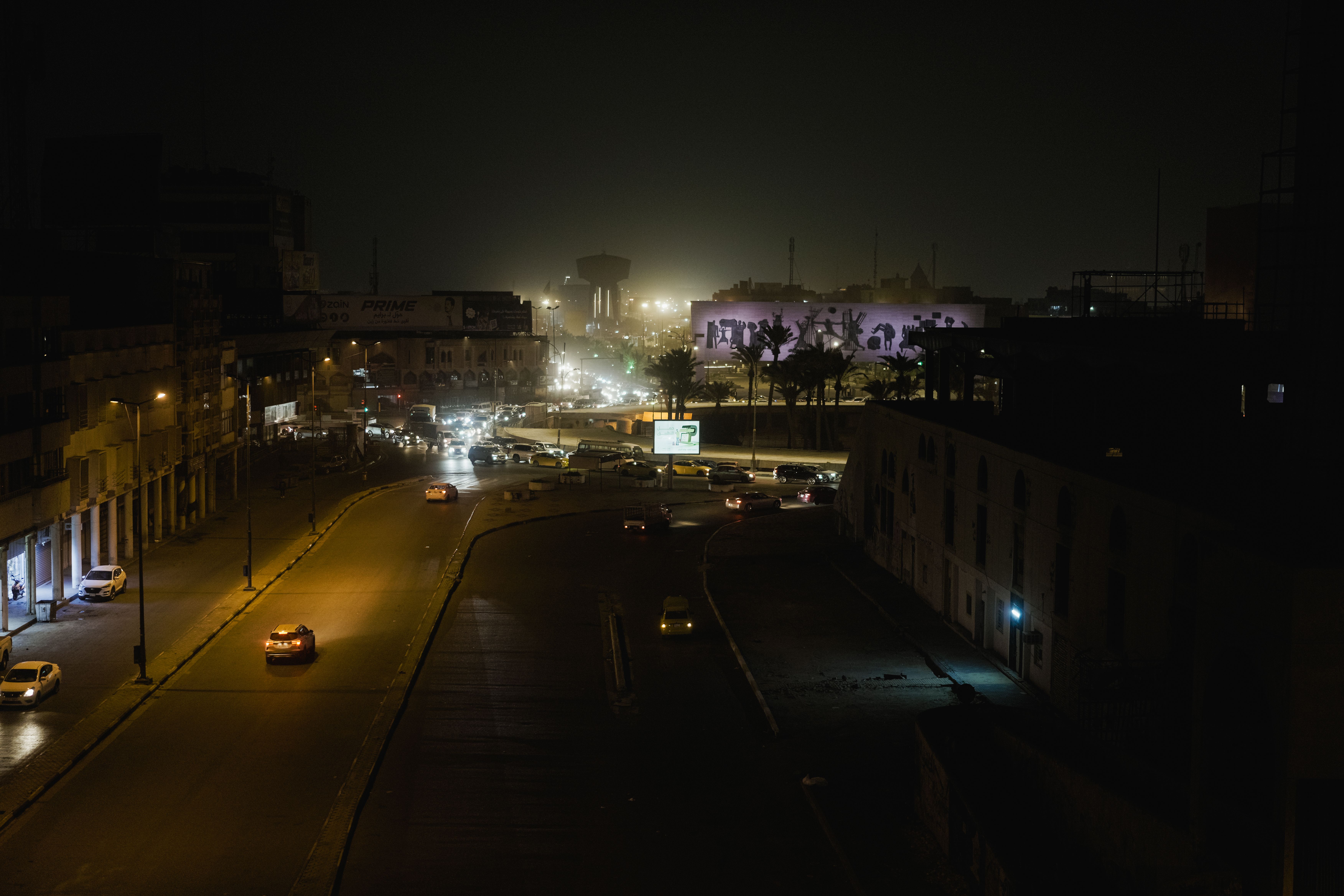 Nighttime City Street with Illuminated Buildings · Free Stock Photo