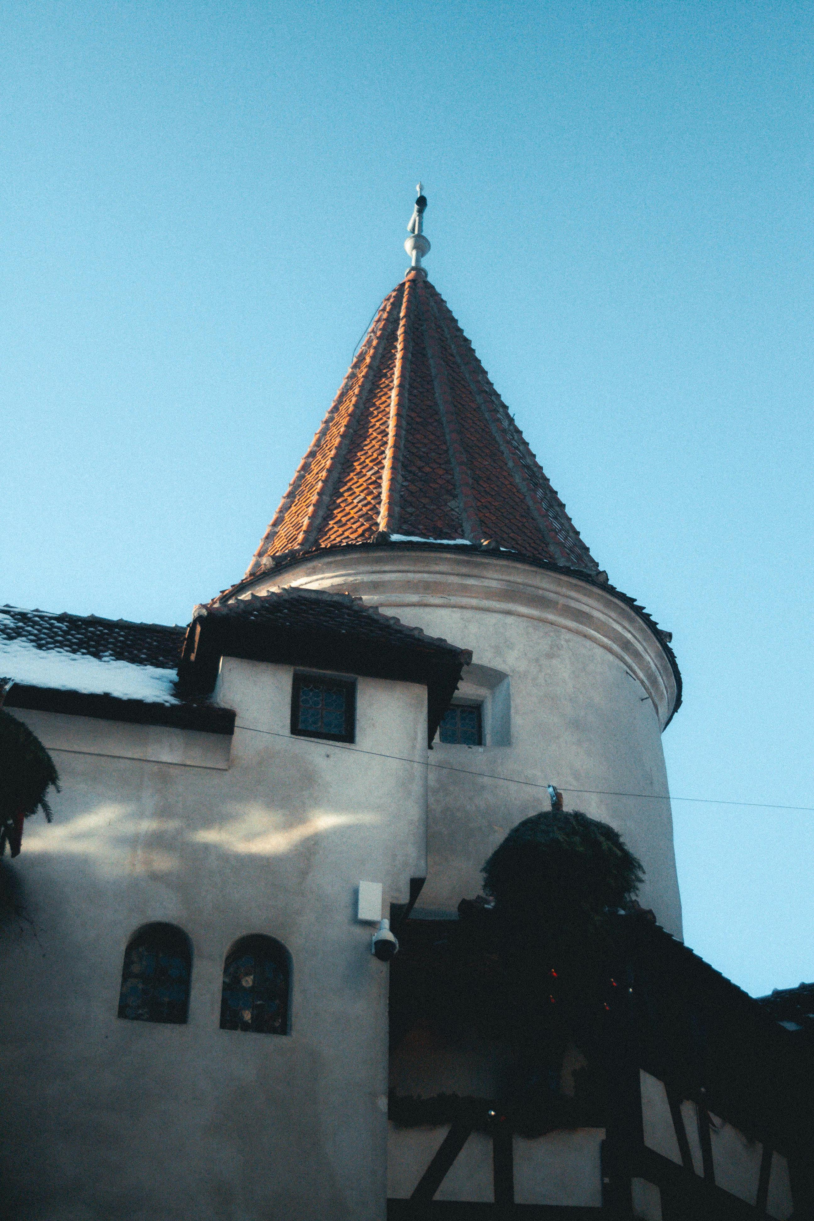 Bran Castle Tower Against a Clear Blue Sky · Free Stock Photo