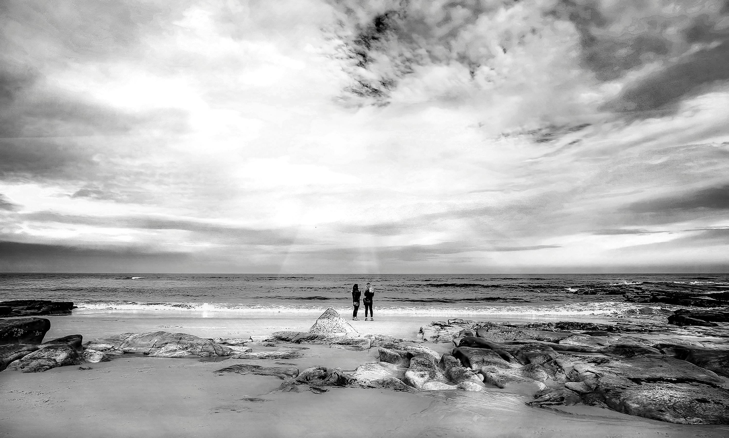 Two People Standing on Seashore · Free Stock Photo