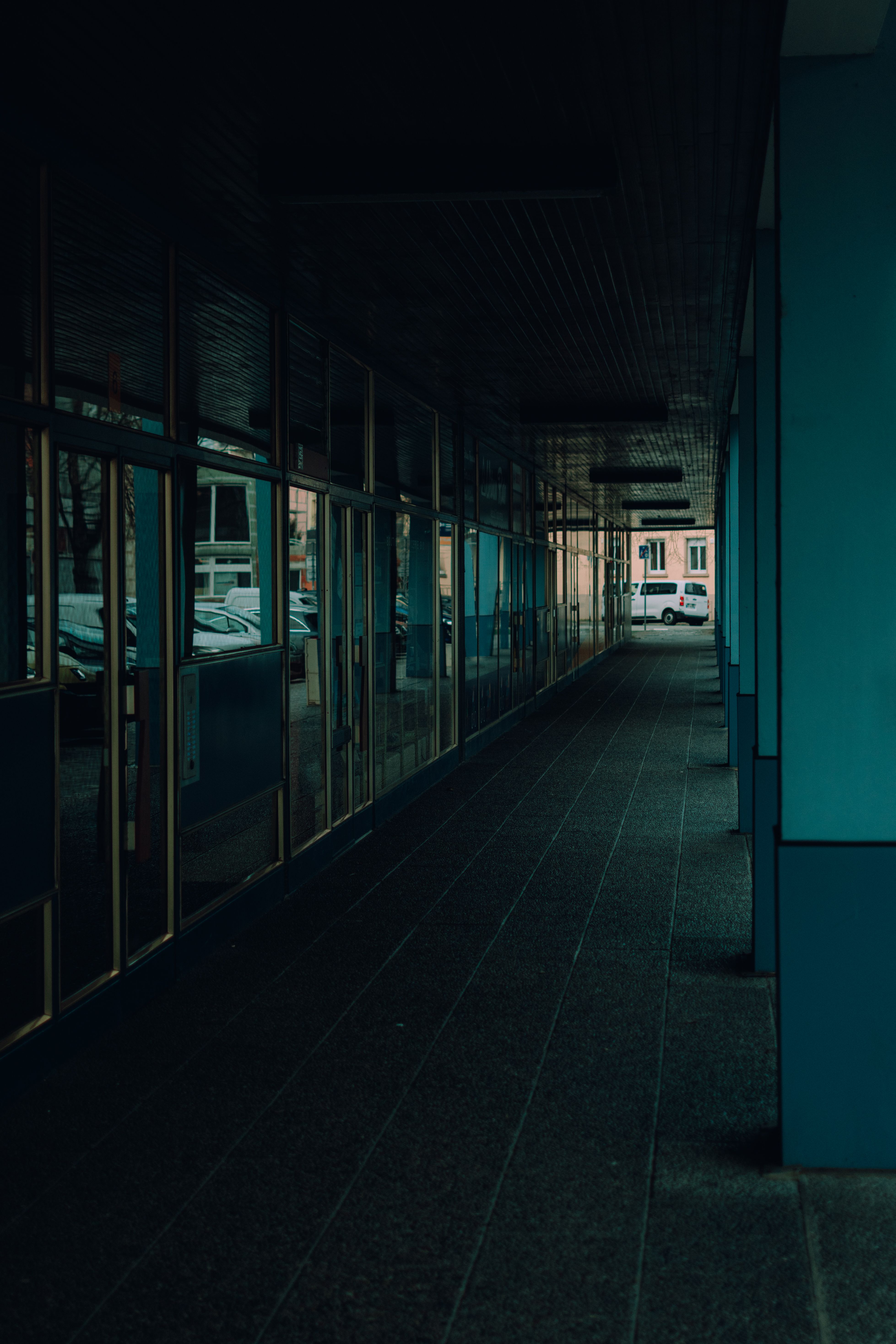 Moody Architectural Walkway with Reflections · Free Stock Photo