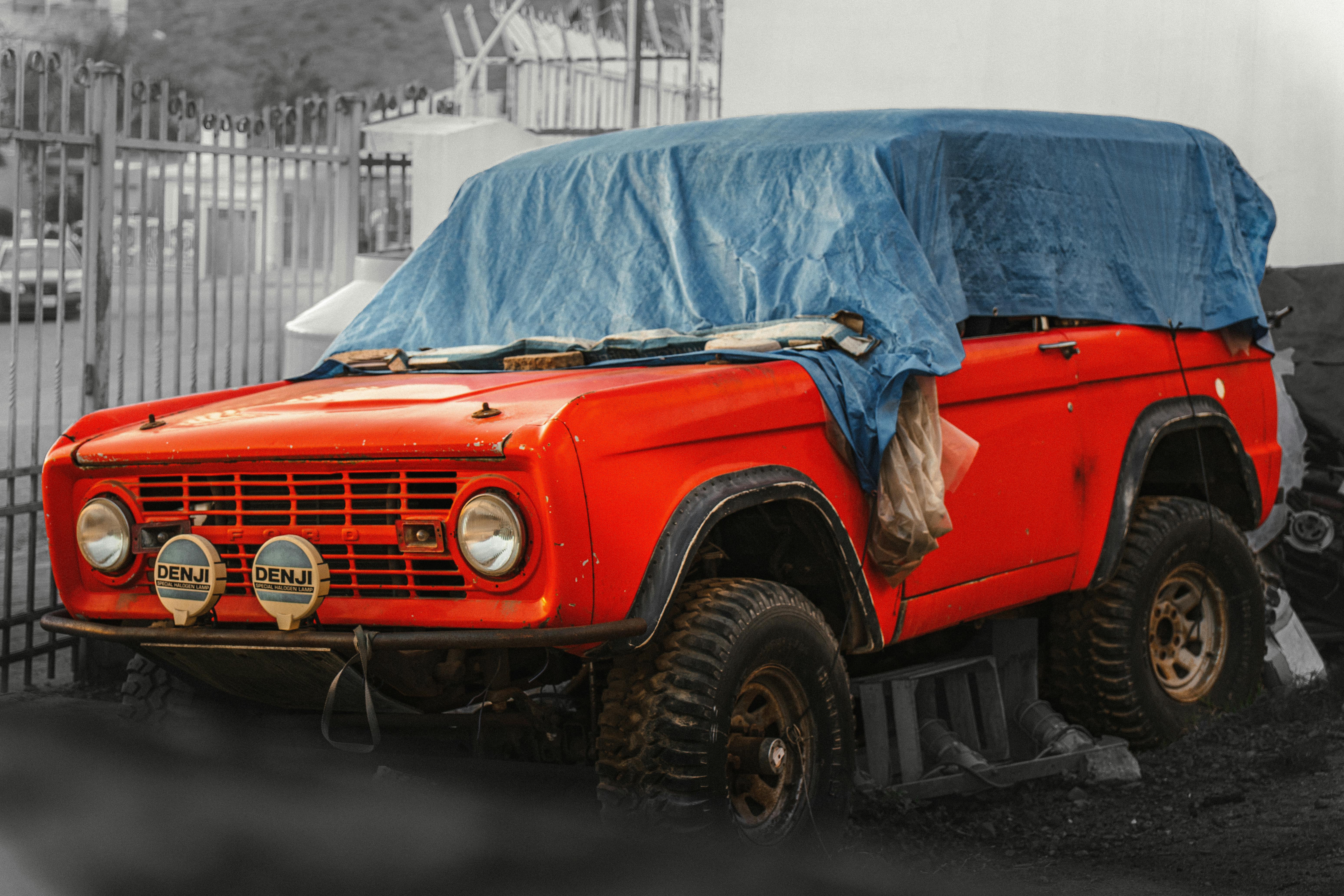 Vintage Red SUV with Blue Tarp Outdoors · Free Stock Photo