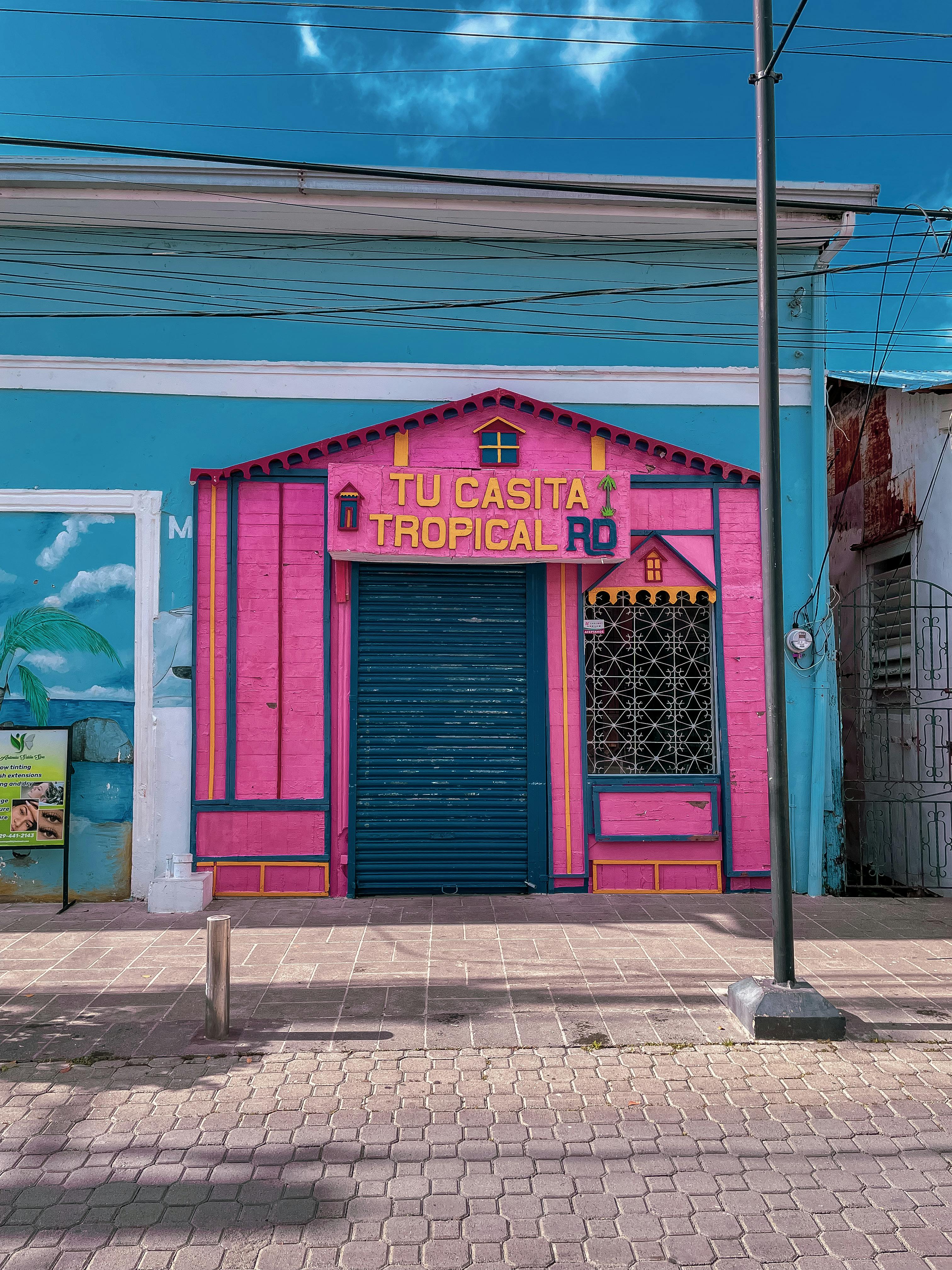 Vibrant Tropical Storefront in Urban Setting · Free Stock Photo