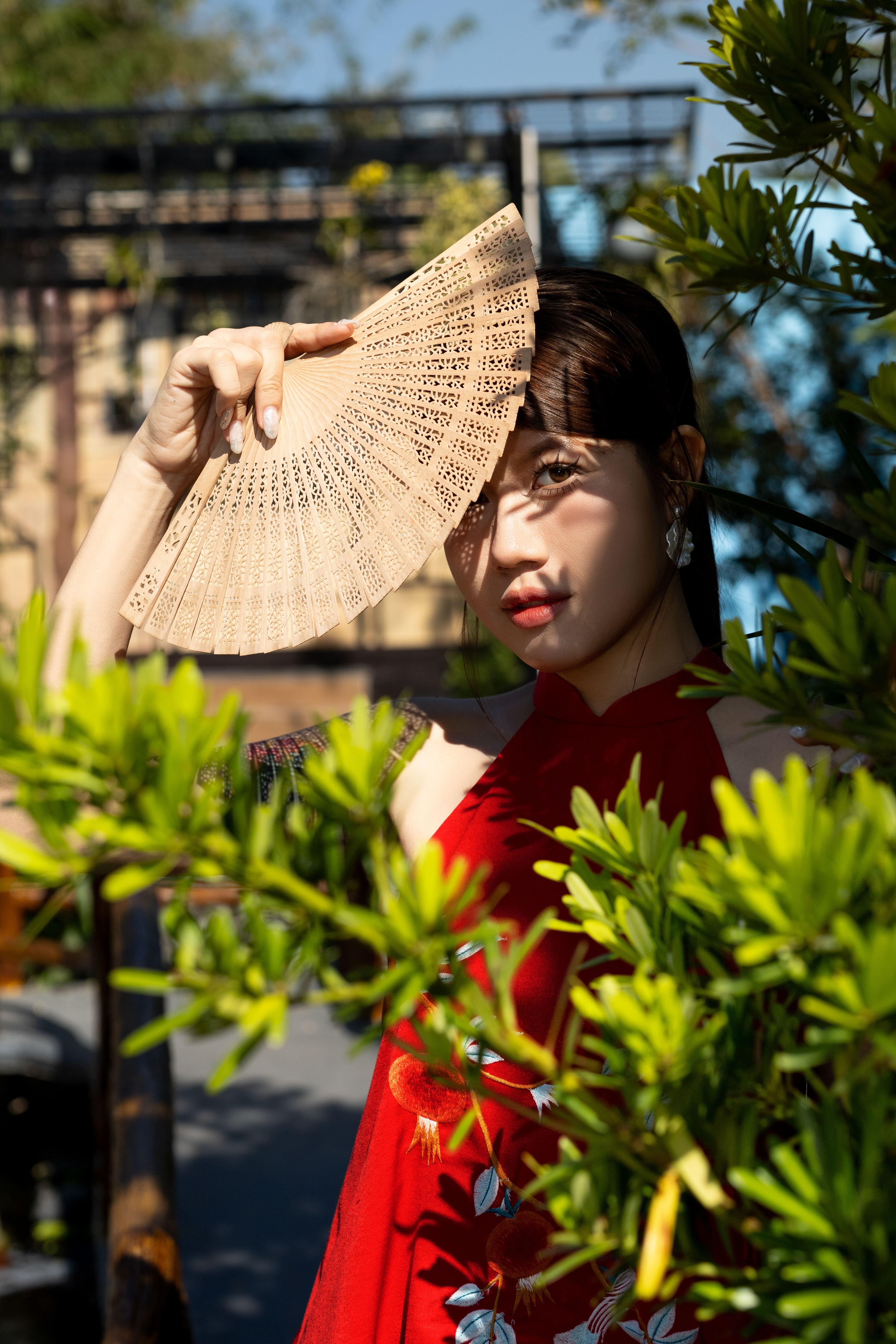 Elegant Woman Posing with Fan in Sunlight · Free Stock Photo
