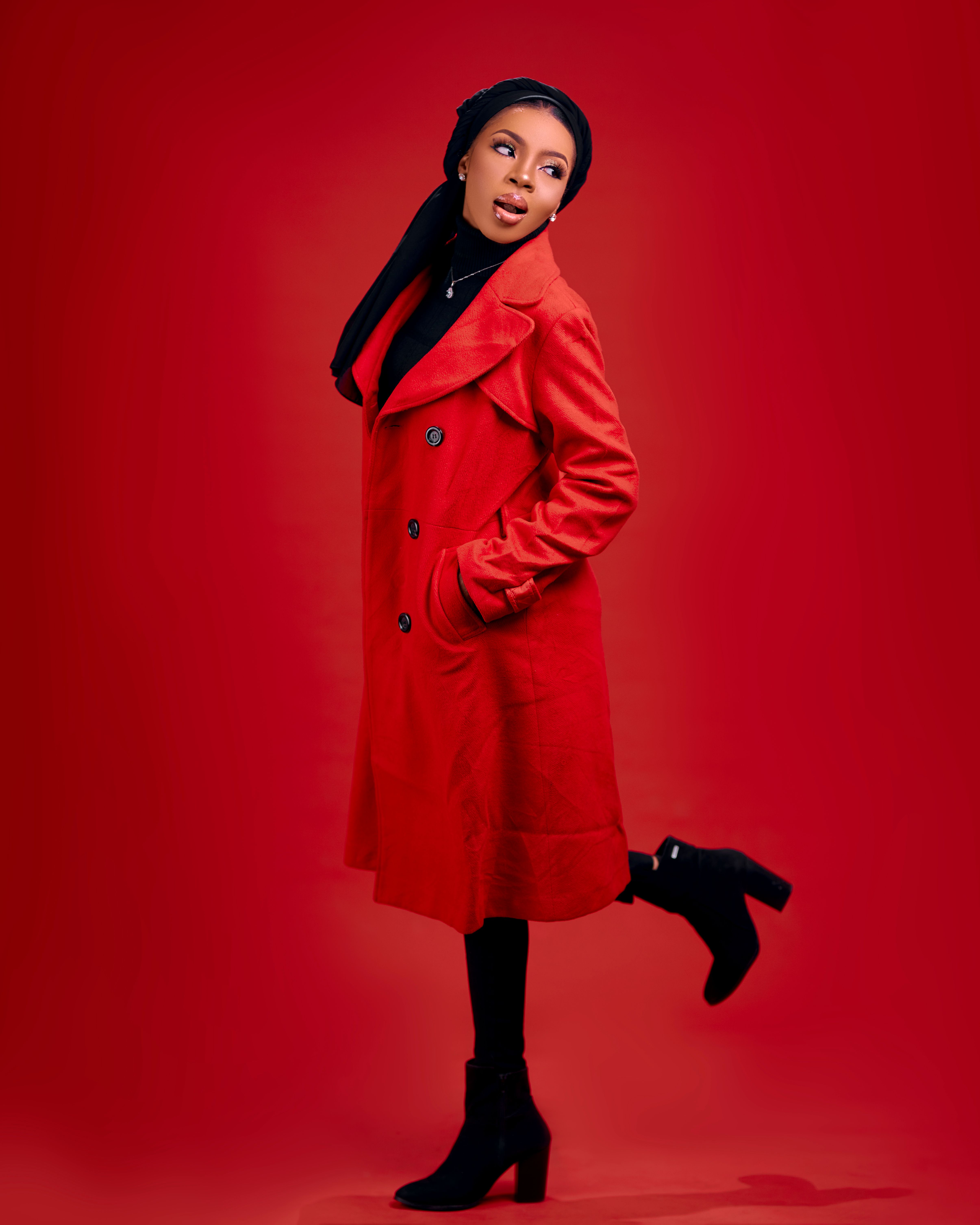 Fashionable woman in red coat striking a pose · Free Stock Photo