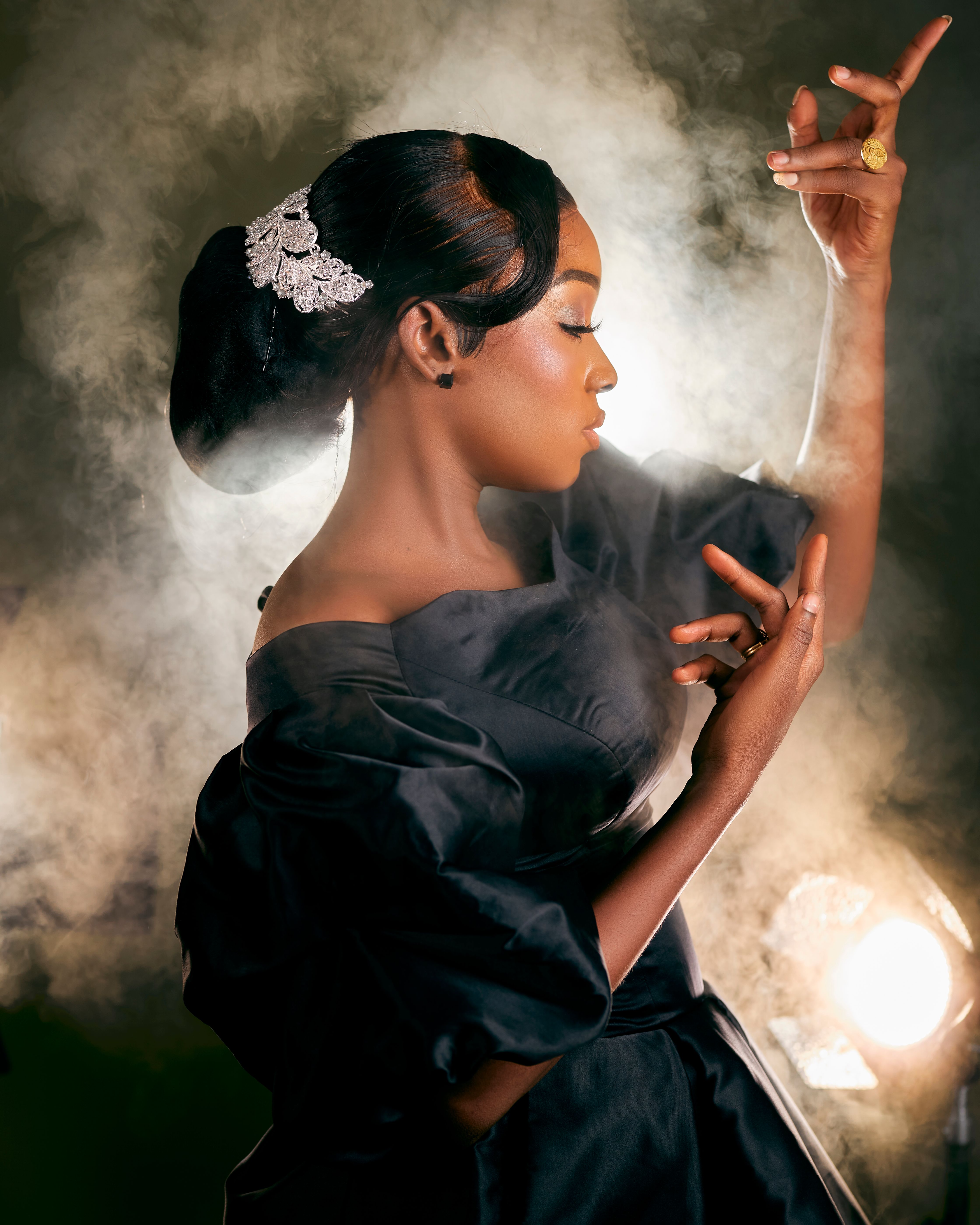 Elegant Woman Posing in Dramatic Lighting · Free Stock Photo