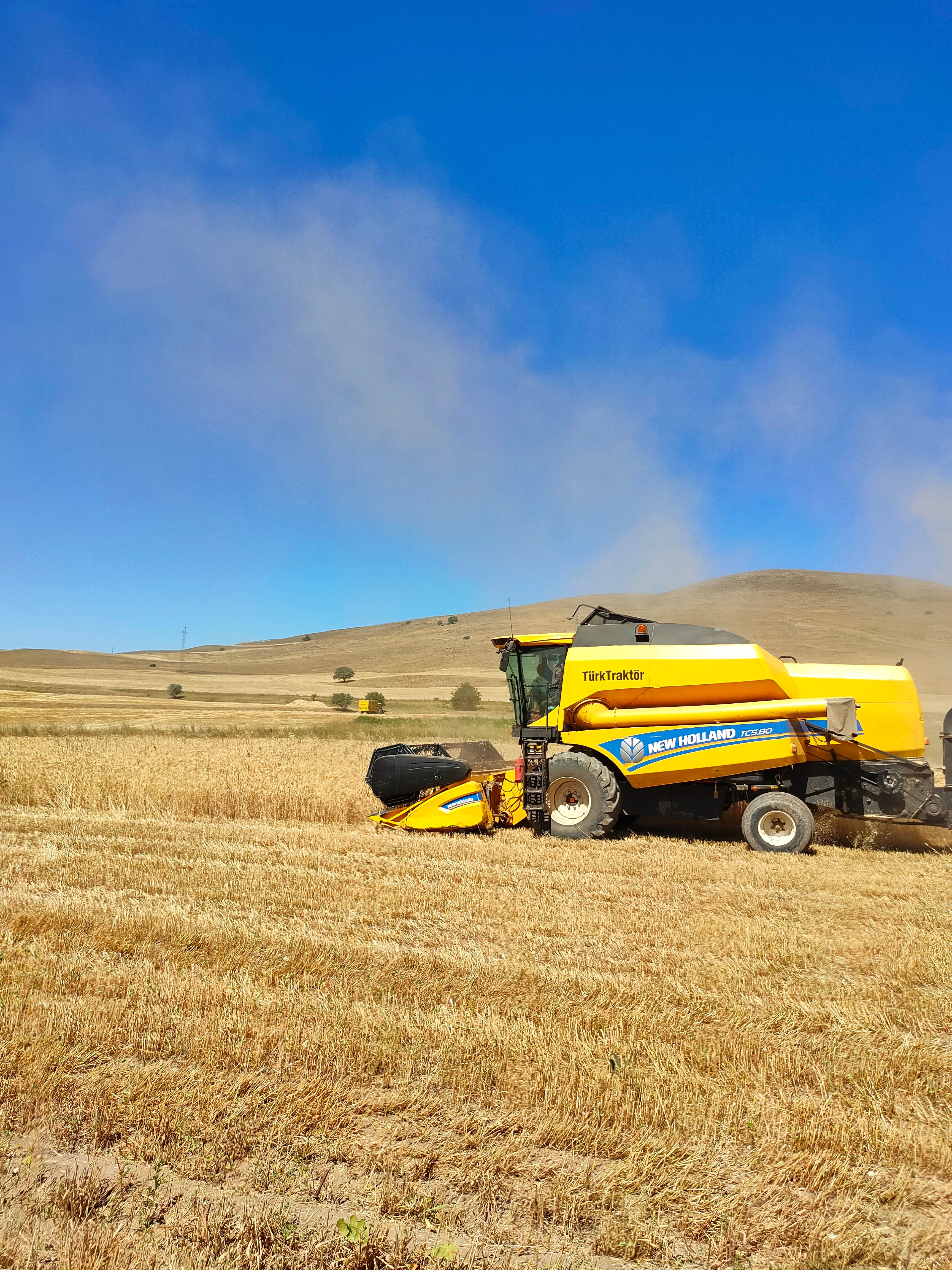 Yellow Combine Harvester in Golden Field · Free Stock Photo