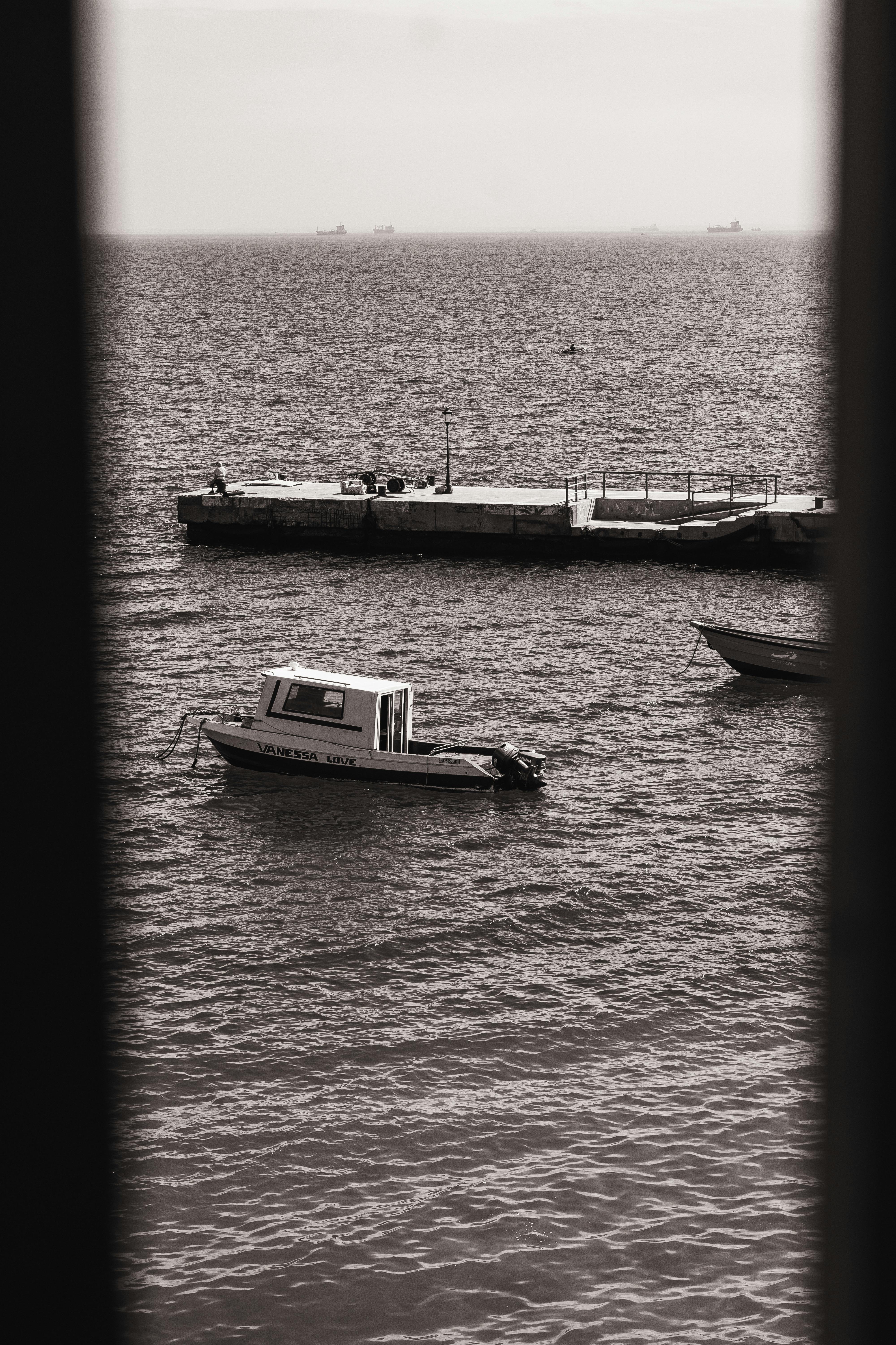 Peaceful Seascape with Fishing Boats and Pier · Free Stock Photo