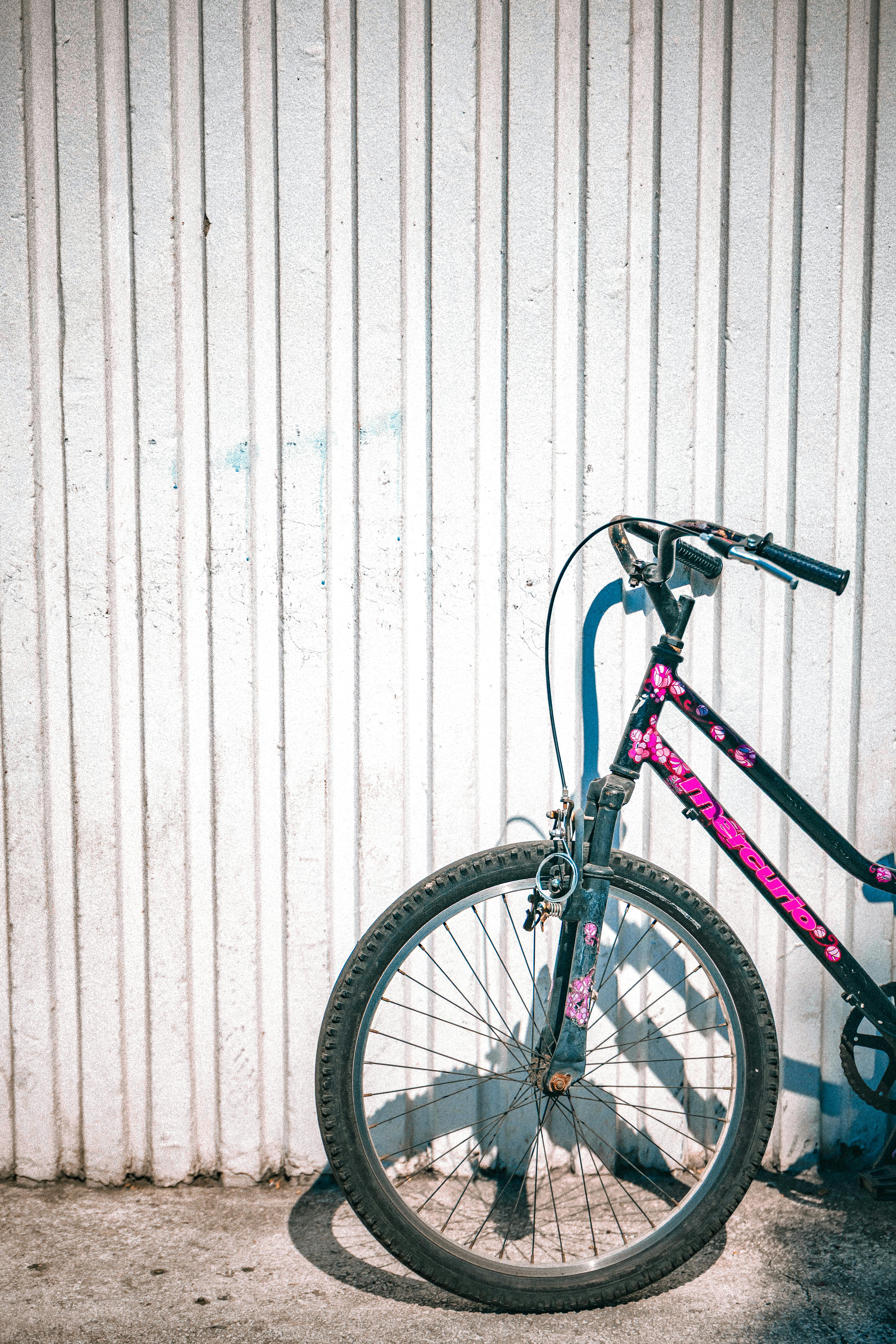 Vibrant Bicycle Against Urban Wall · Free Stock Photo
