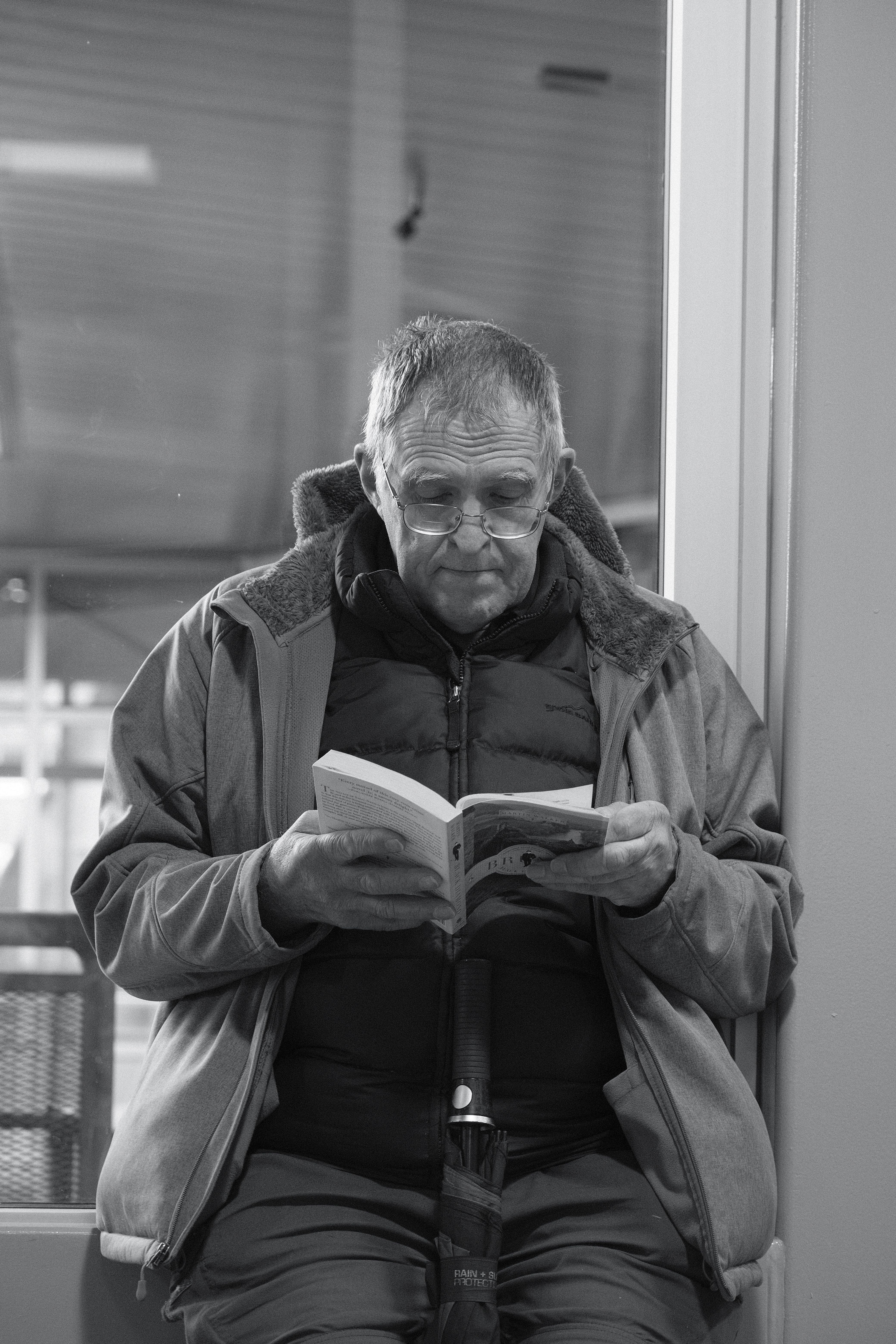 Monochrome Portrait of an Elderly Man Reading · Free Stock Photo