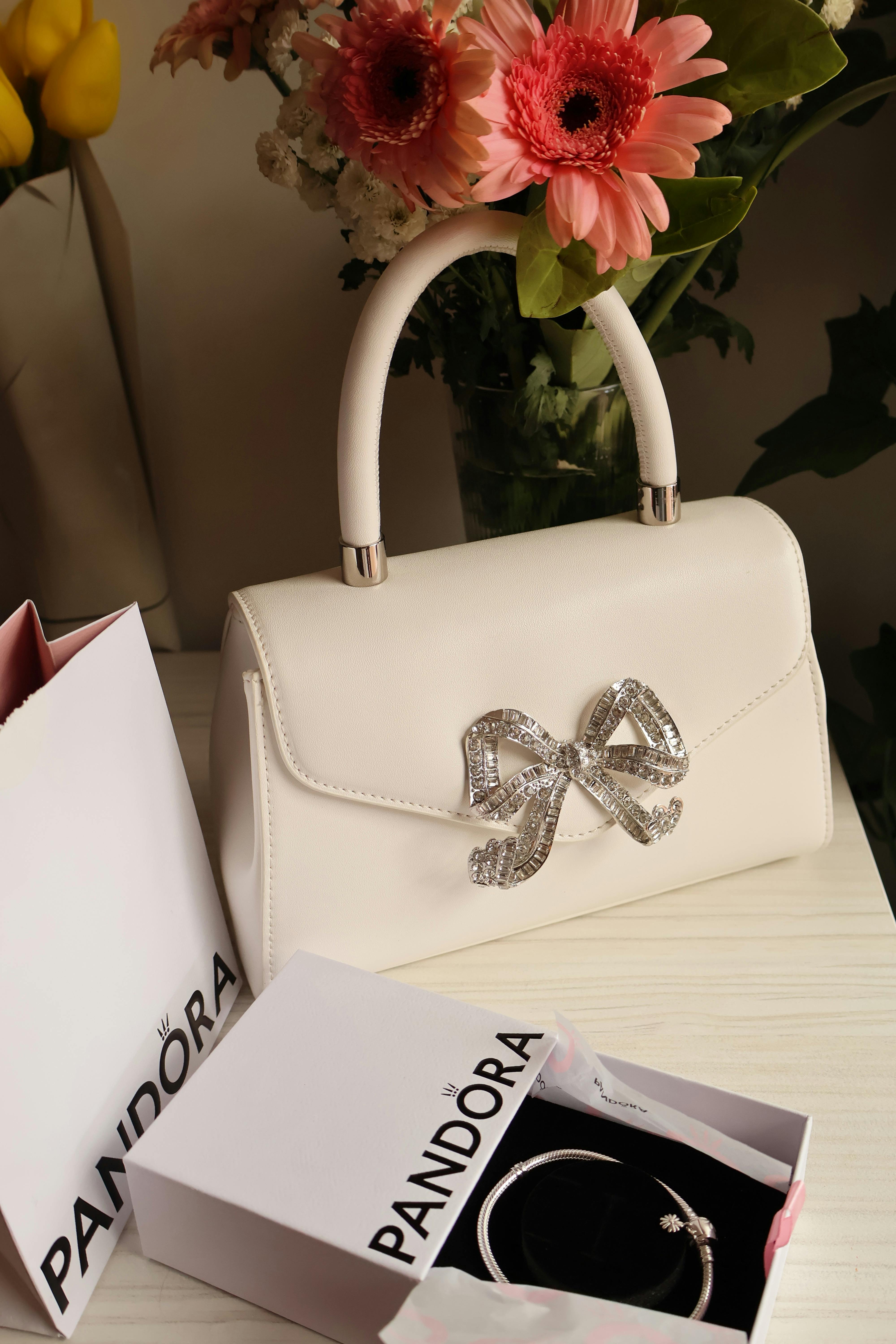 Elegant White Handbag with Pandora Jewelry · Free Stock Photo