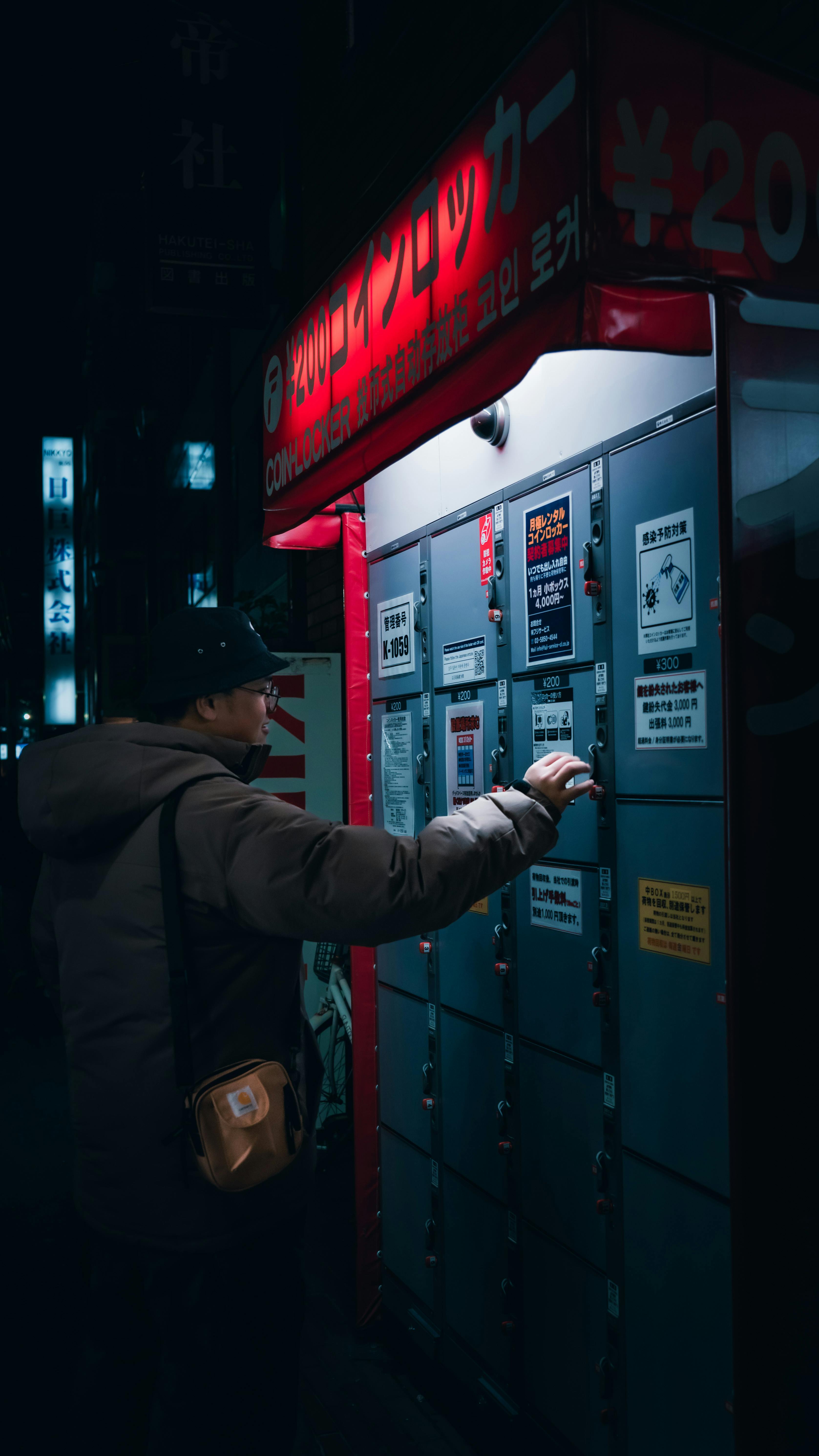 Person Using Vending Machine at Night in City · Free Stock Photo