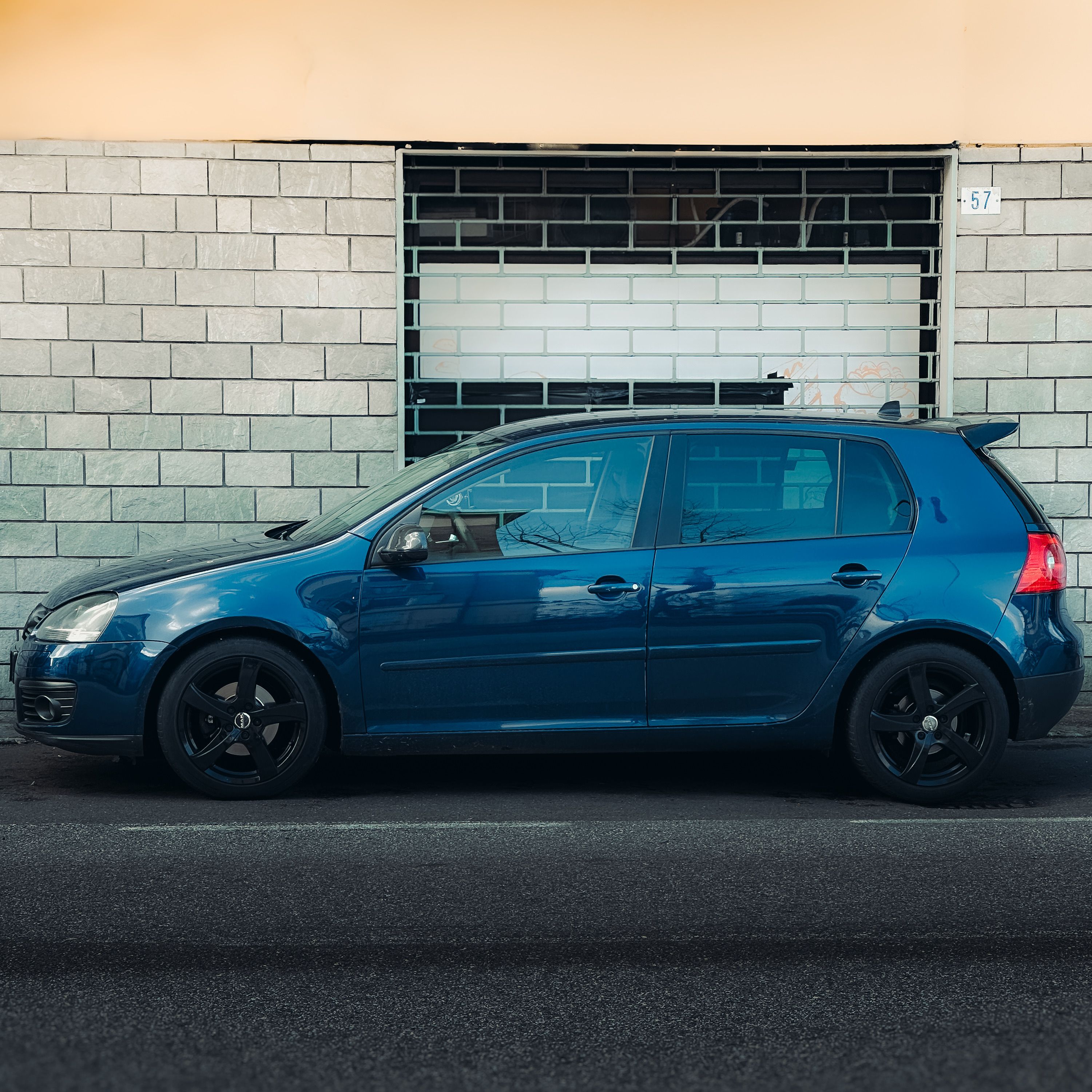 Blue Hatchback Car Parked on Urban Street · Free Stock Photo
