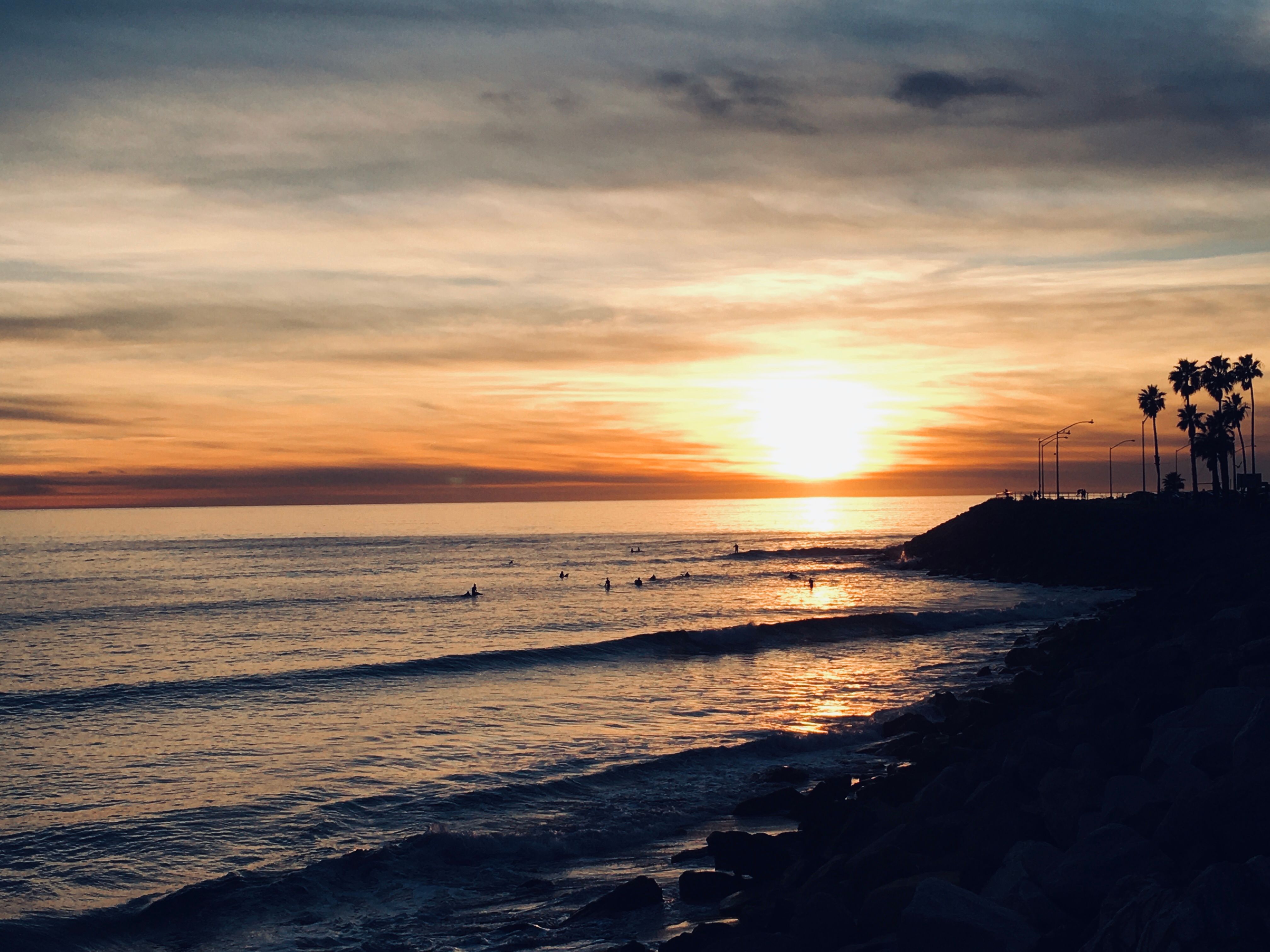 Serene Sunset Over Malibu Beach with Surfers · Free Stock Photo
