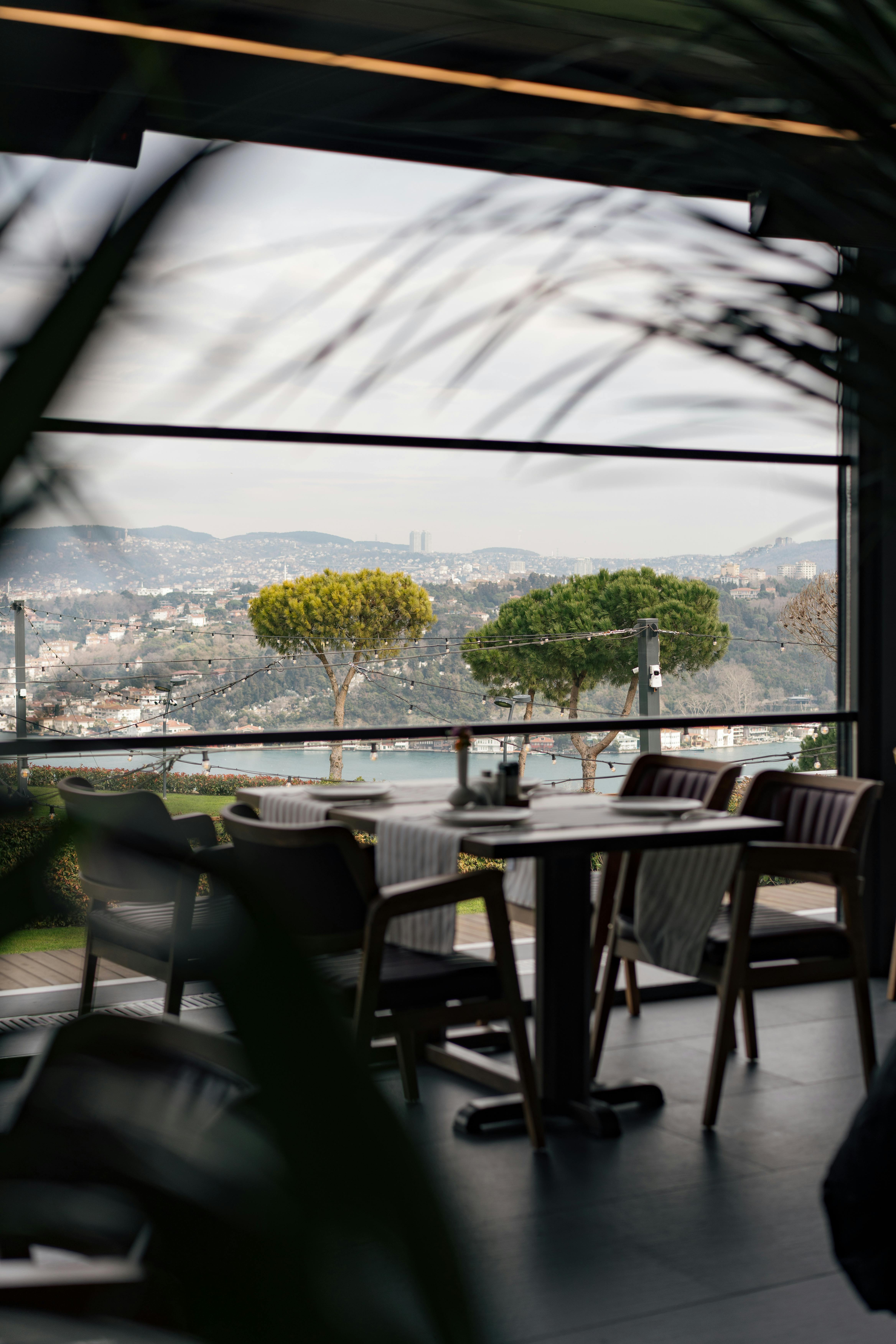 Scenic Restaurant View Overlooking Coastal Cityscape · Free Stock Photo