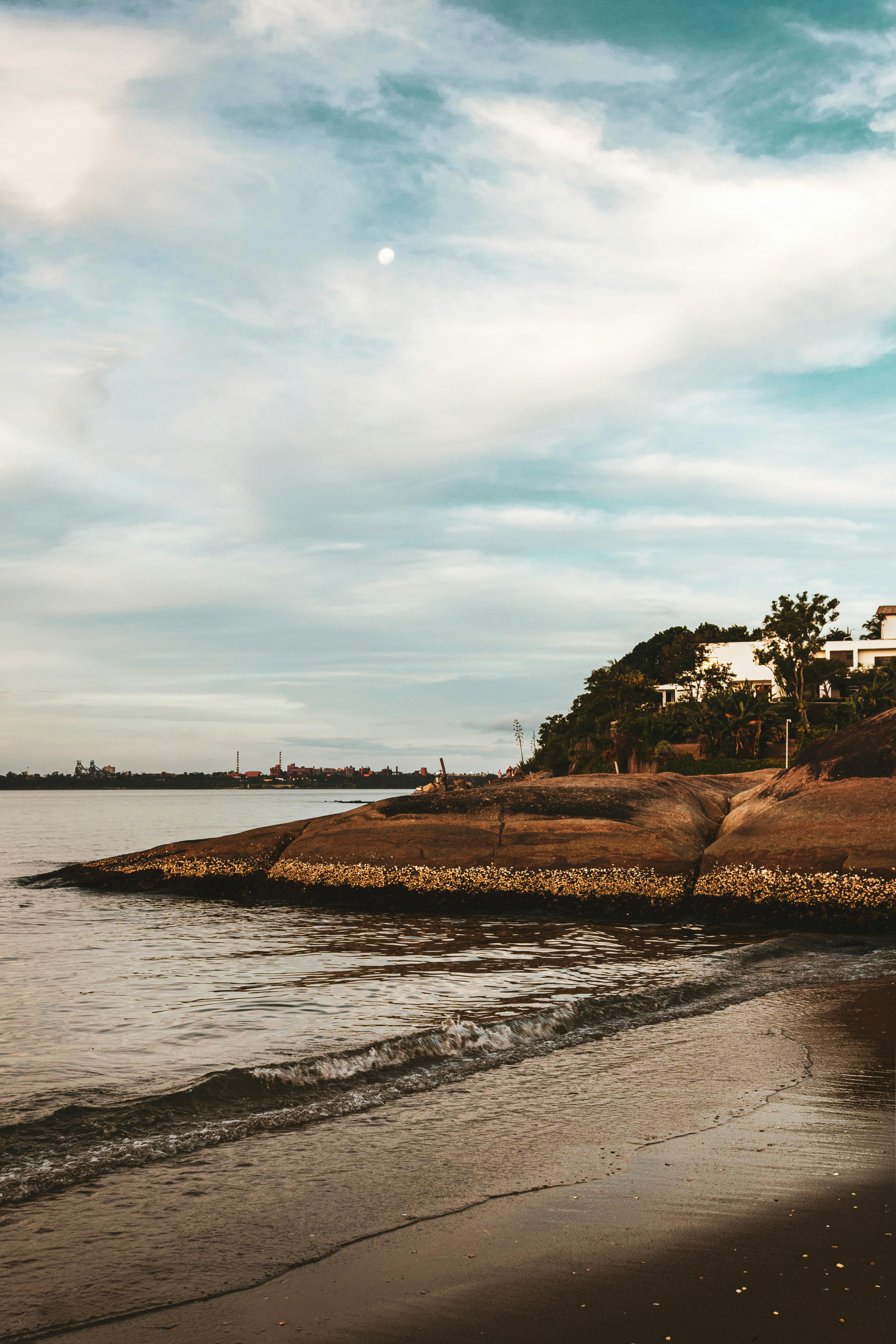 Coastal Scene with Moon and Rocky Shoreline in Brazil · Free Stock Photo